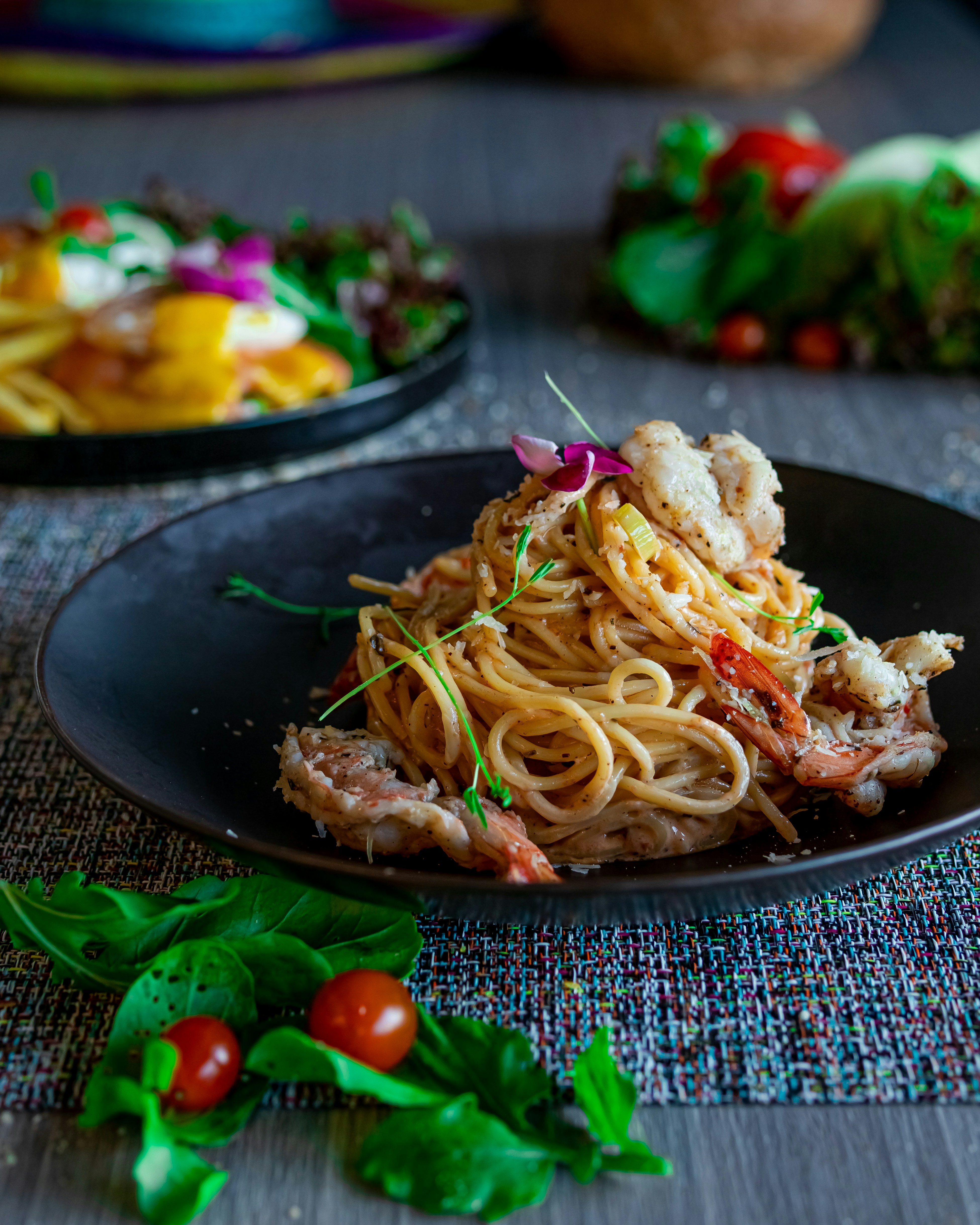 Spaghetti Stack: Shrimp, Microgreens, and Edible Flowers on a Matte Plate