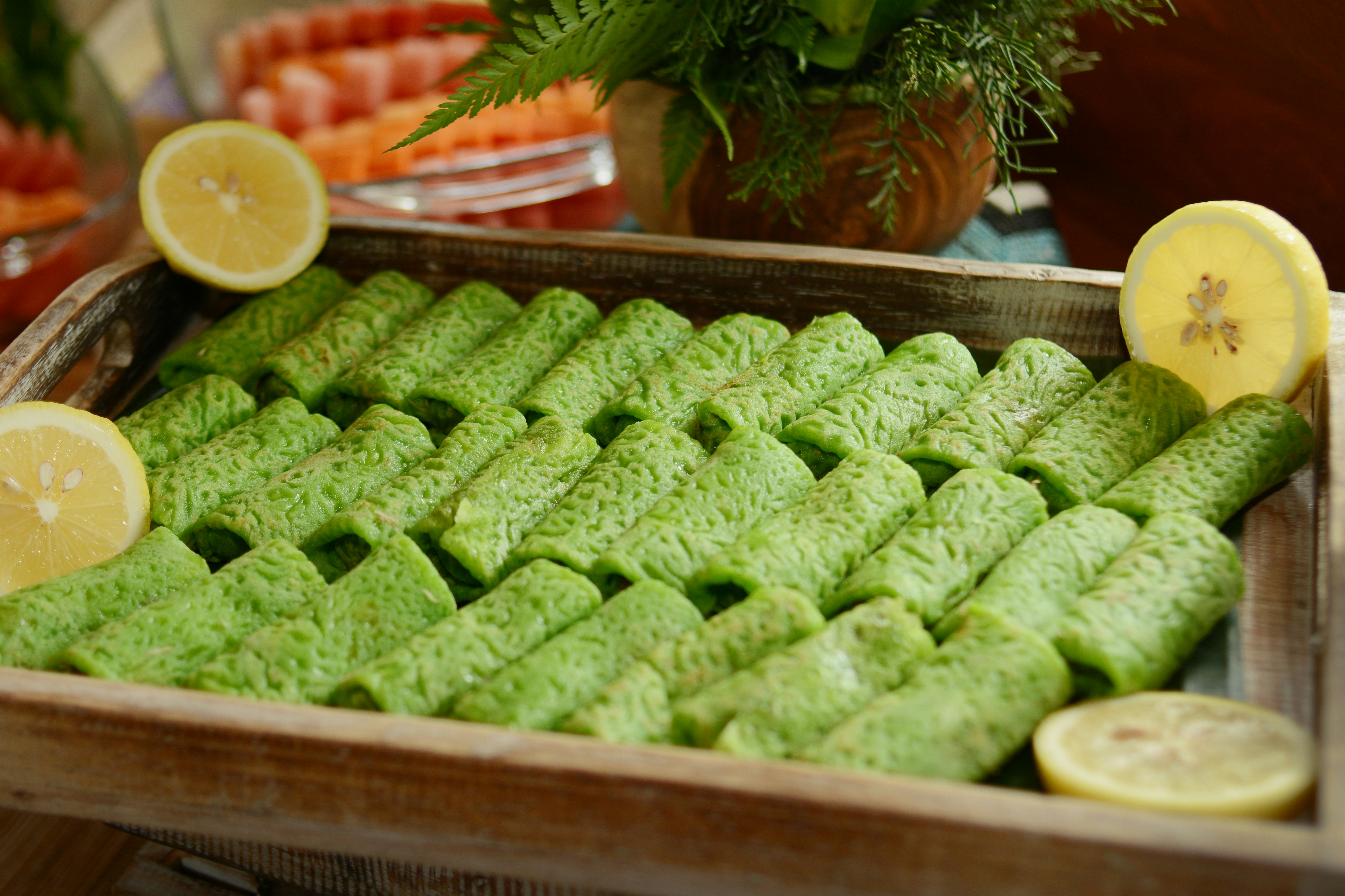 Emerald Herb Rolls on a Rustic Tray: Lemon Wedges as Bright Accents