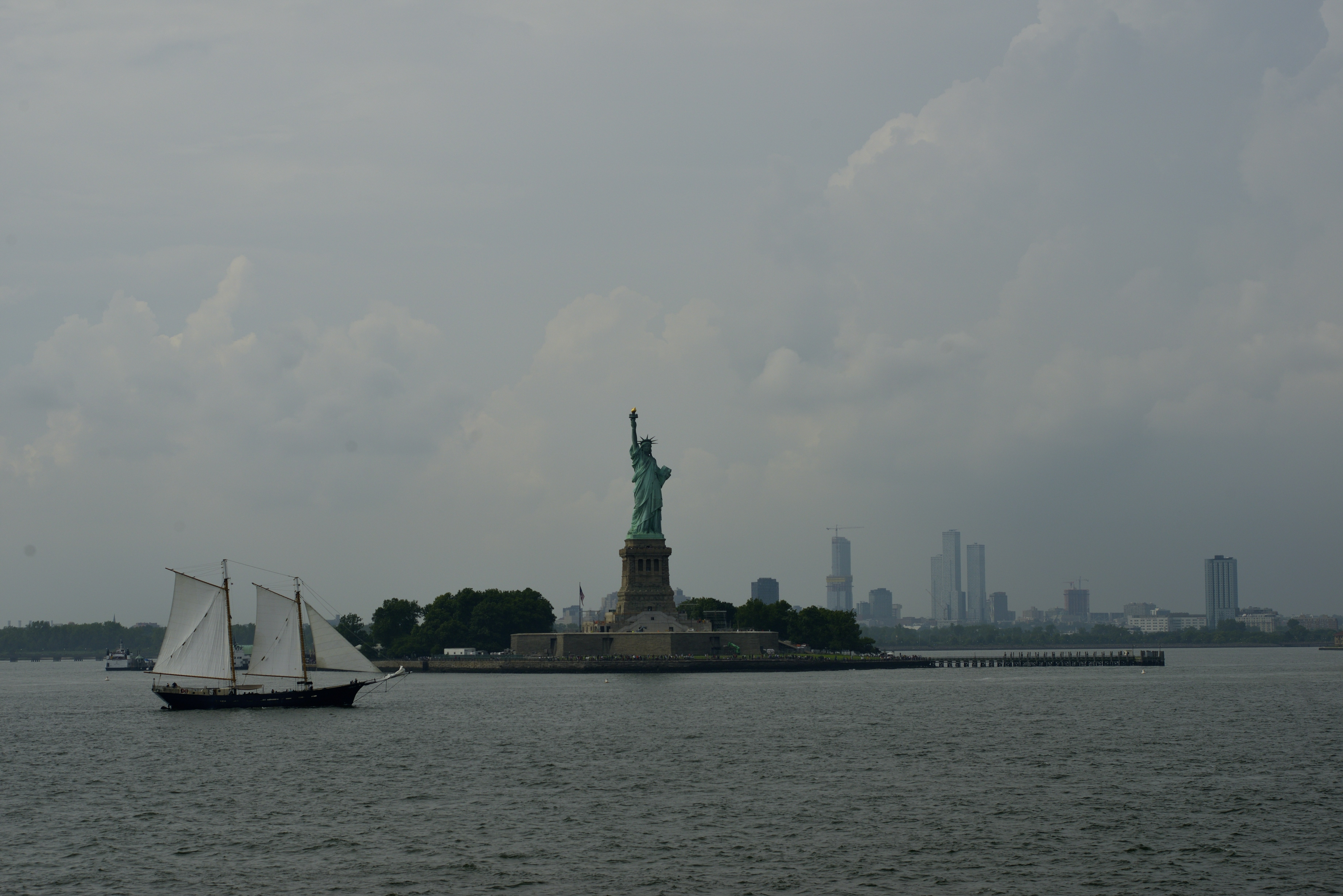 Harbor Sentinel: Liberty Island in a Misty Skyline Moment