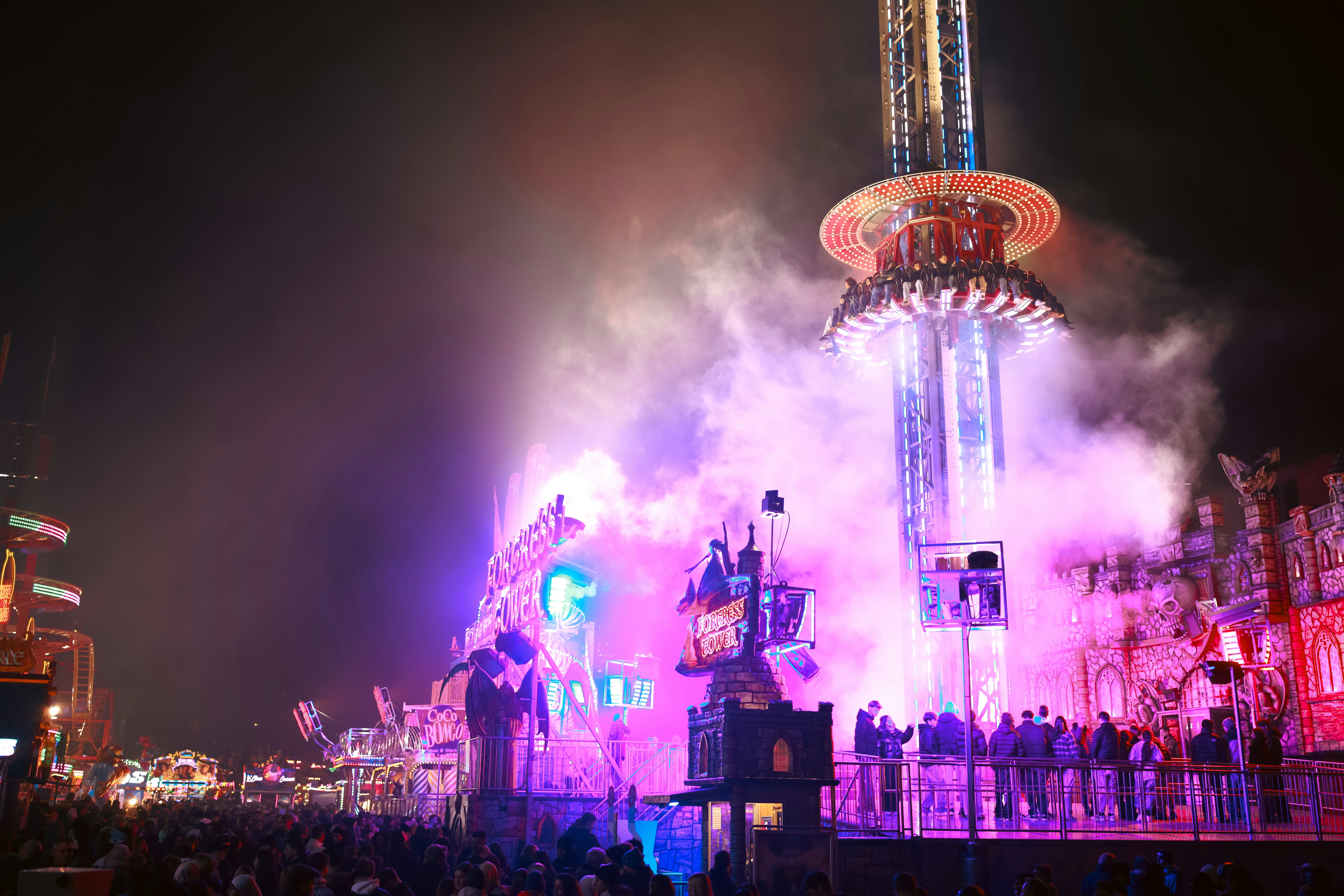 Neon Ring Ascendancy: Midnight carnival tower slicing through lavender fog