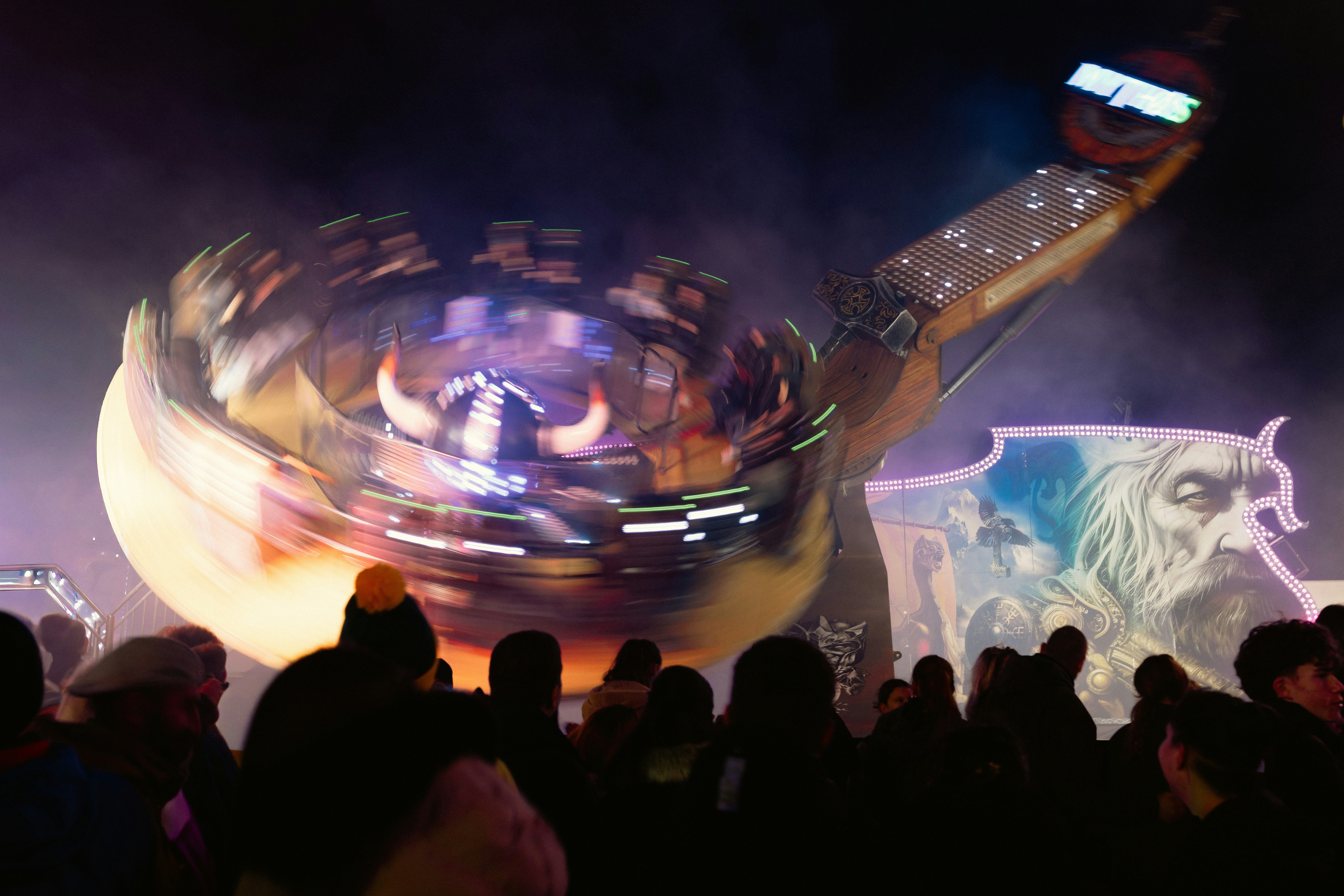 Spin of the Night: Carnival Carousel Blurred by Motion and Crowd