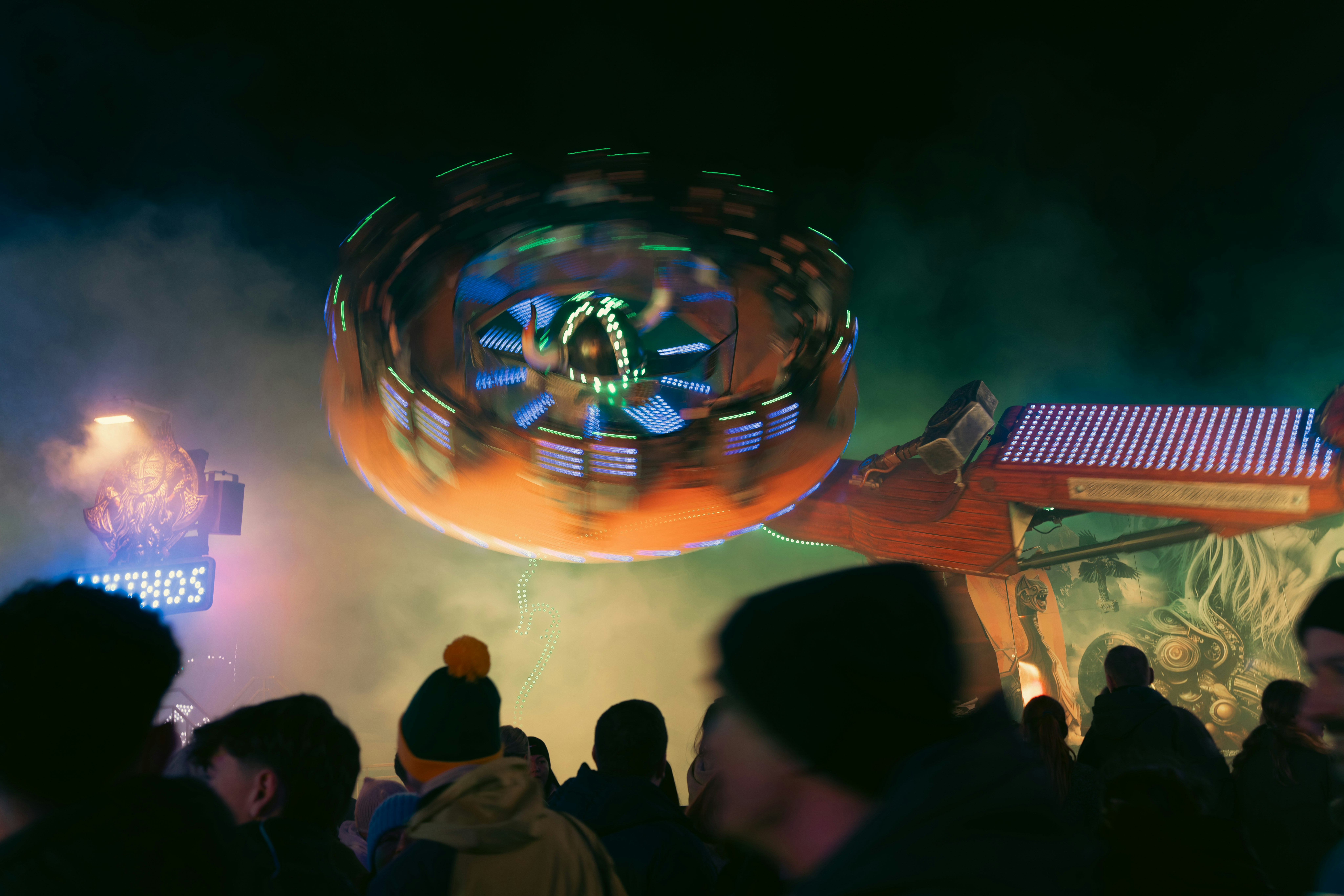 Whirling Neon Ring Over Foggy Carnival