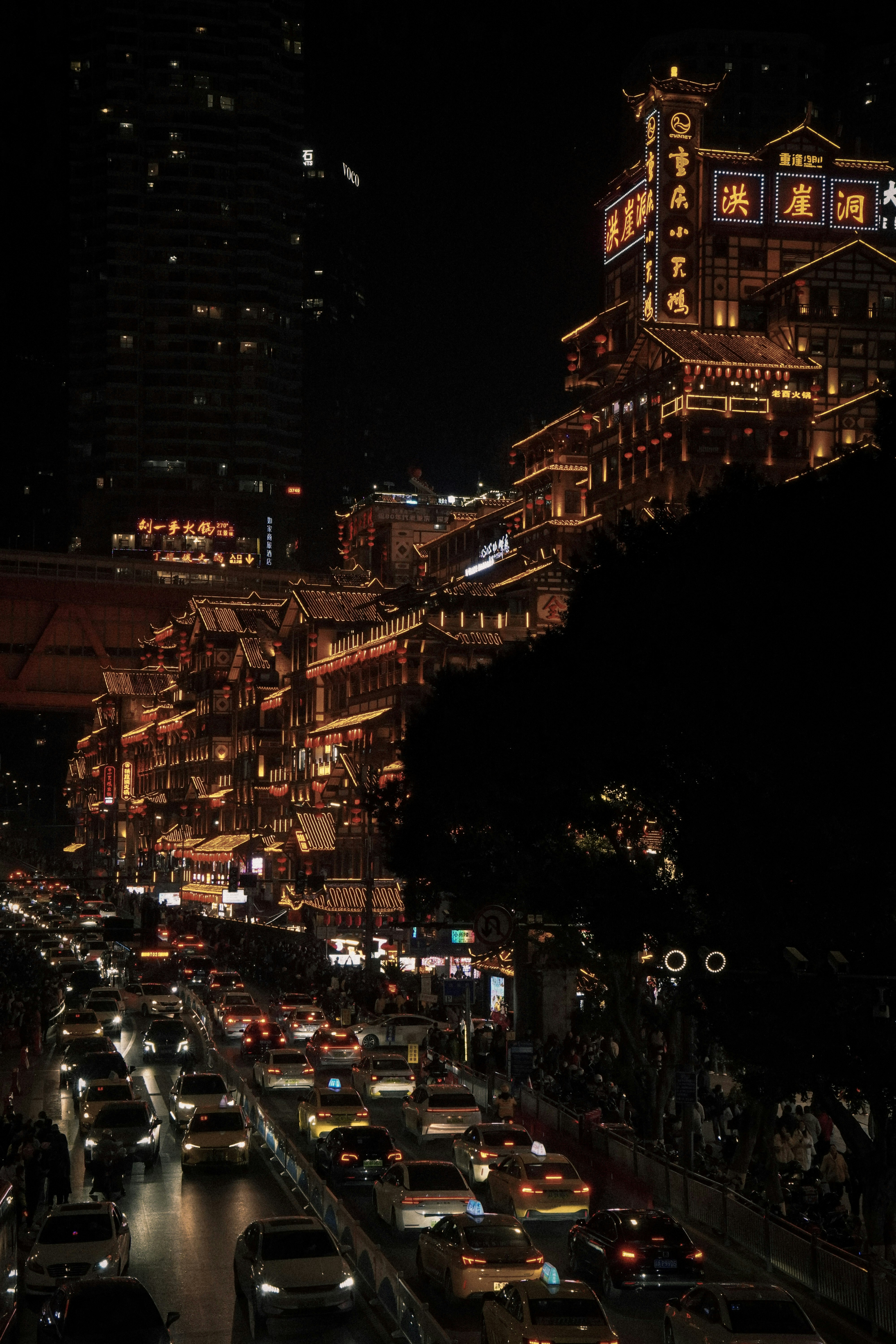 Neon Canopy Over a Heritage Street: Night Traffic in a Lantern-Lit Corridor