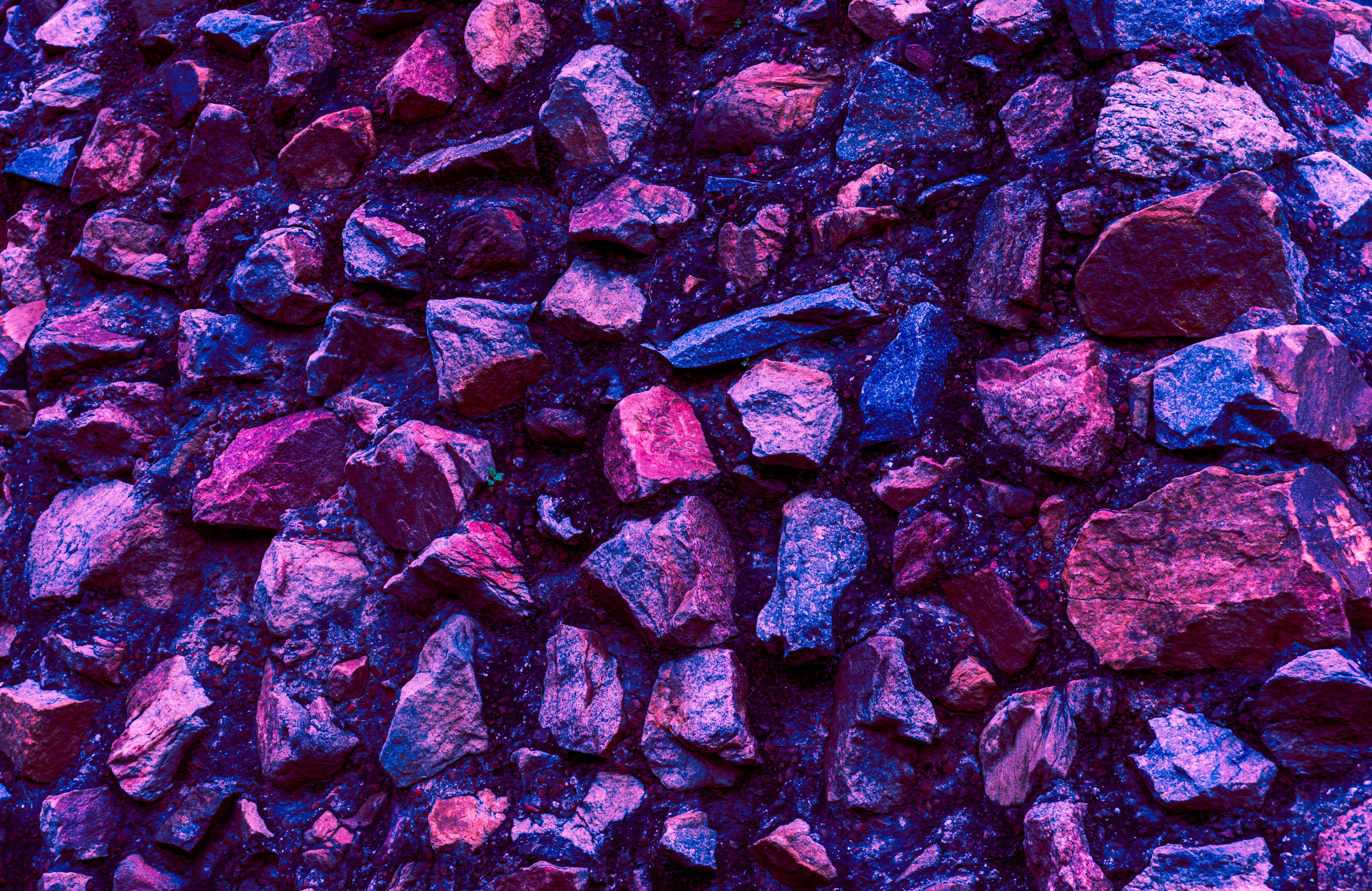 The contrast between natural rock textures and neon hues makes it suitable for digital art, graphic design, album covers, or backgrounds in sci-fi and cyberpunk themes.