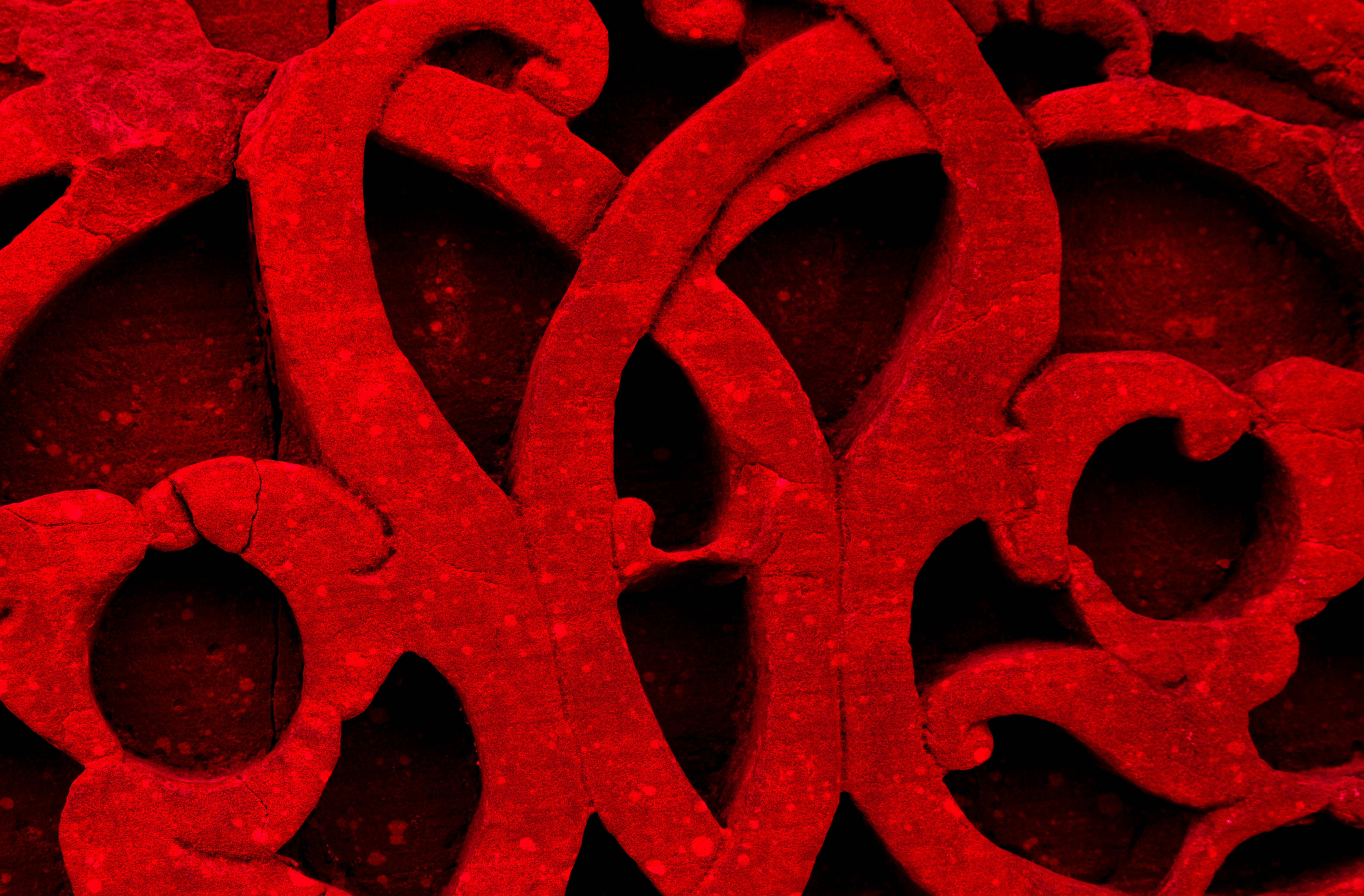Crimson Lace: Macro Close-Up of Interwoven Red Wrought-Iron Patterns
