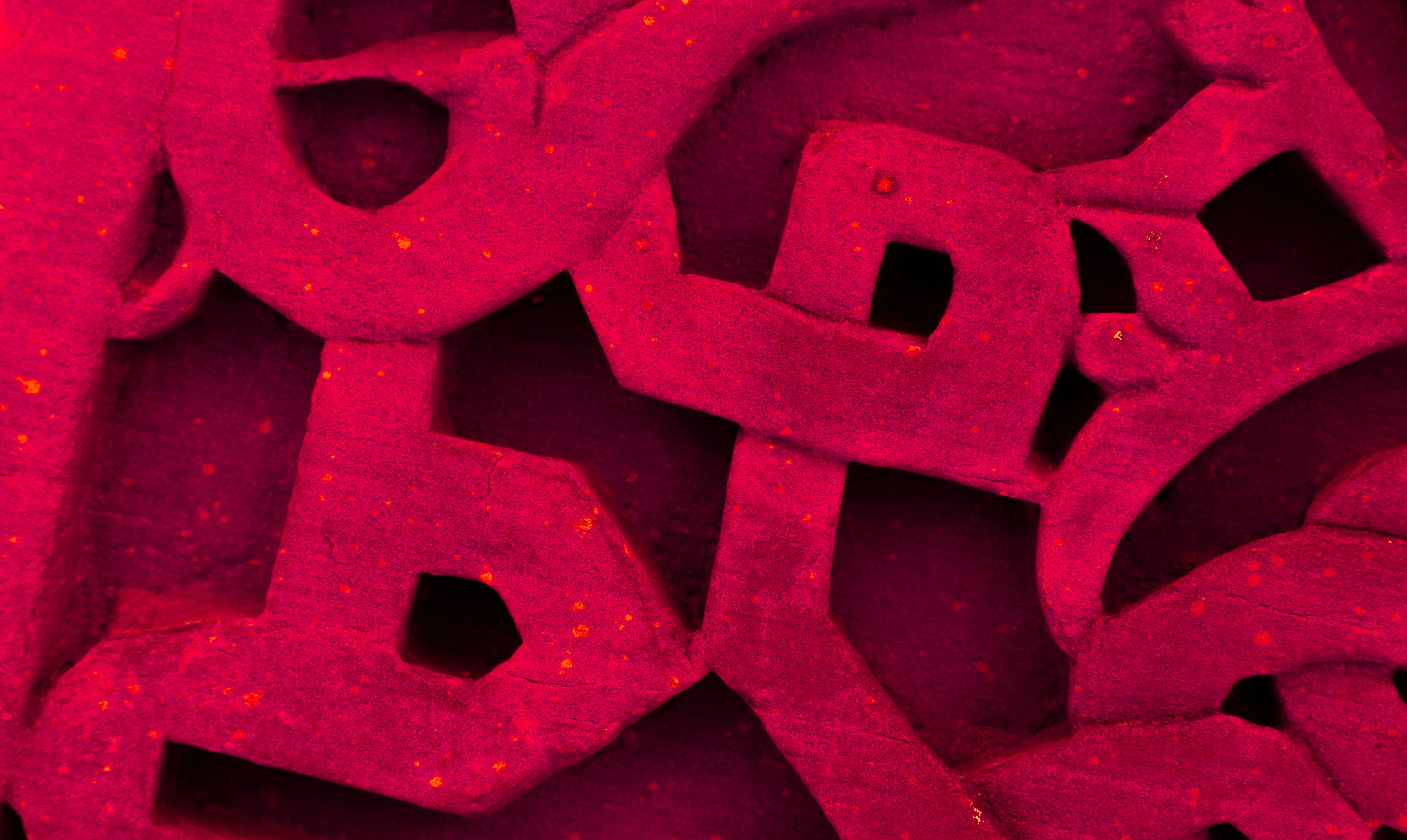 Crimson Lattice: a macro study of interlocking red voids and speckled light