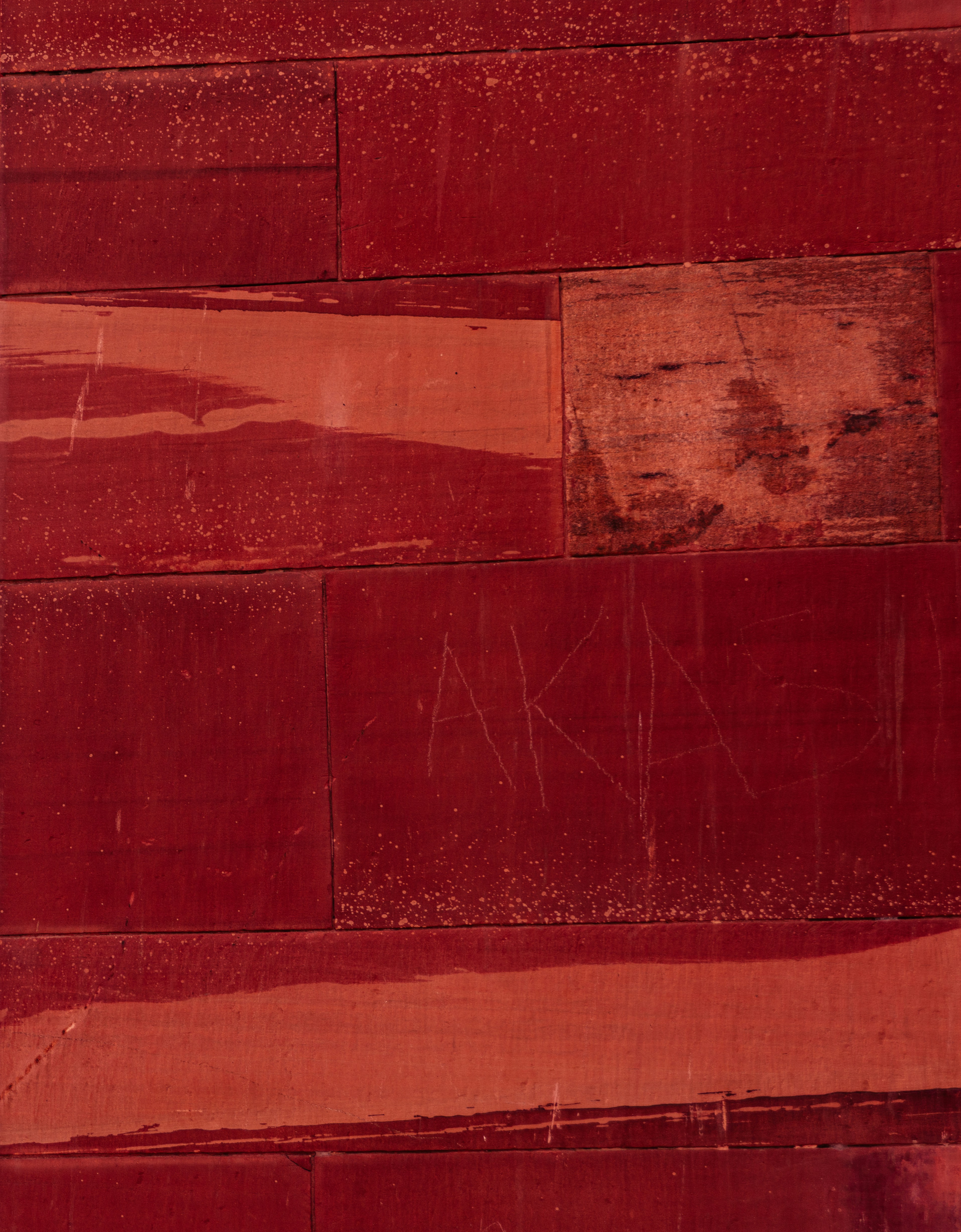 Ember-Red Brickwork: A Weathered Panel Emerges from the Wall