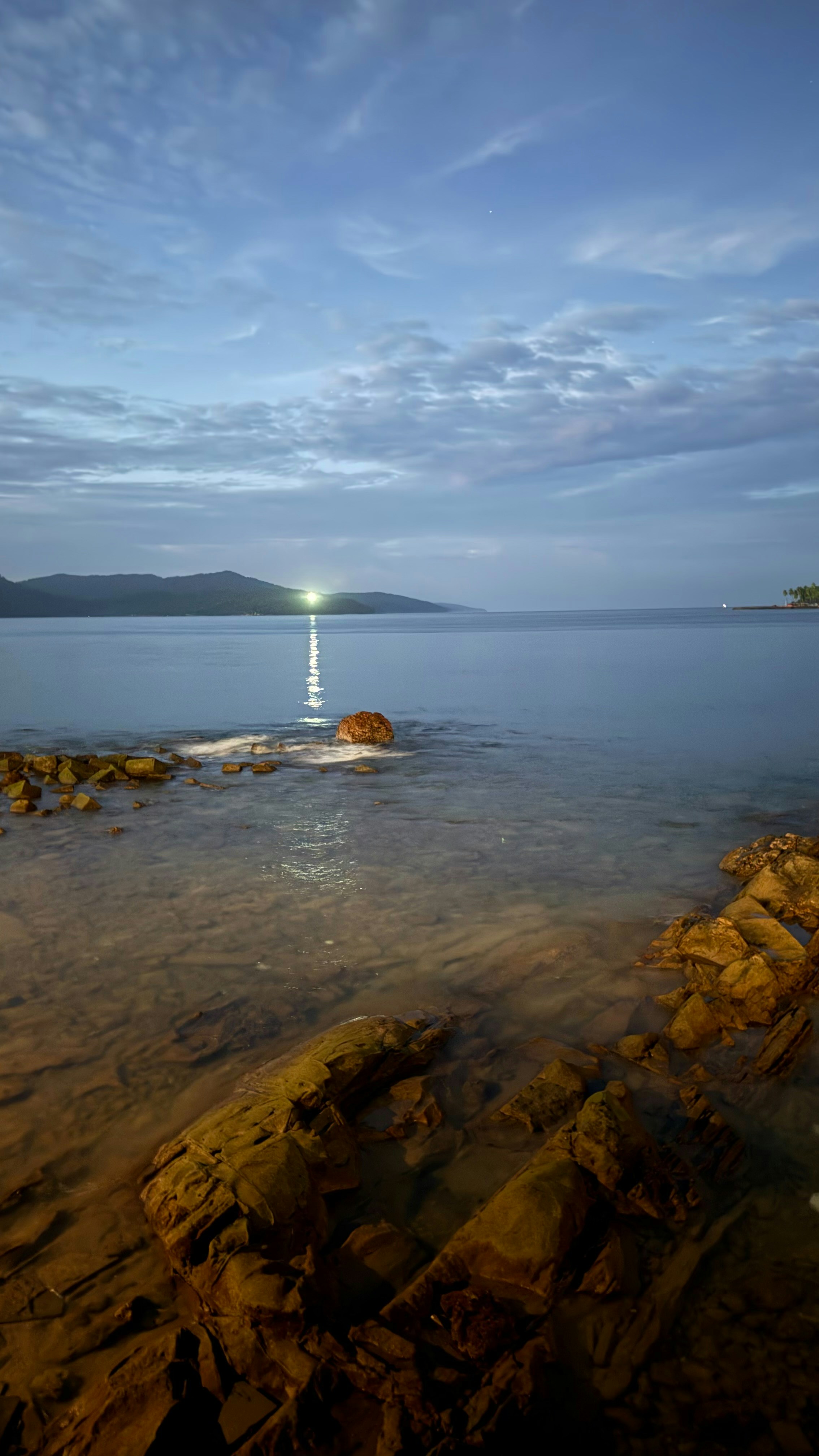 Beacon at Dusk Over a Rock-Studded Shore
