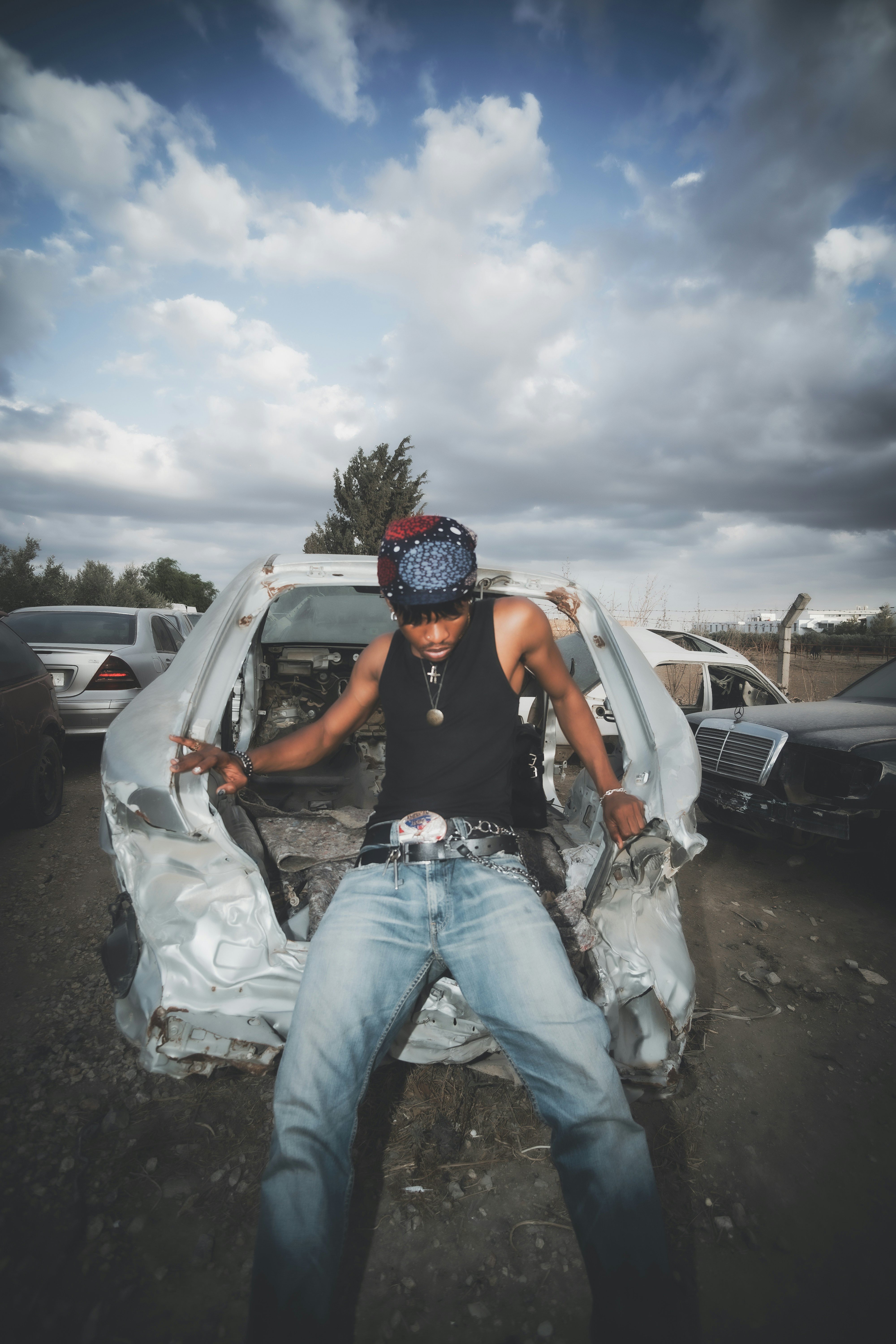 Rust and Resolve: Portrait in a Junkyard Car