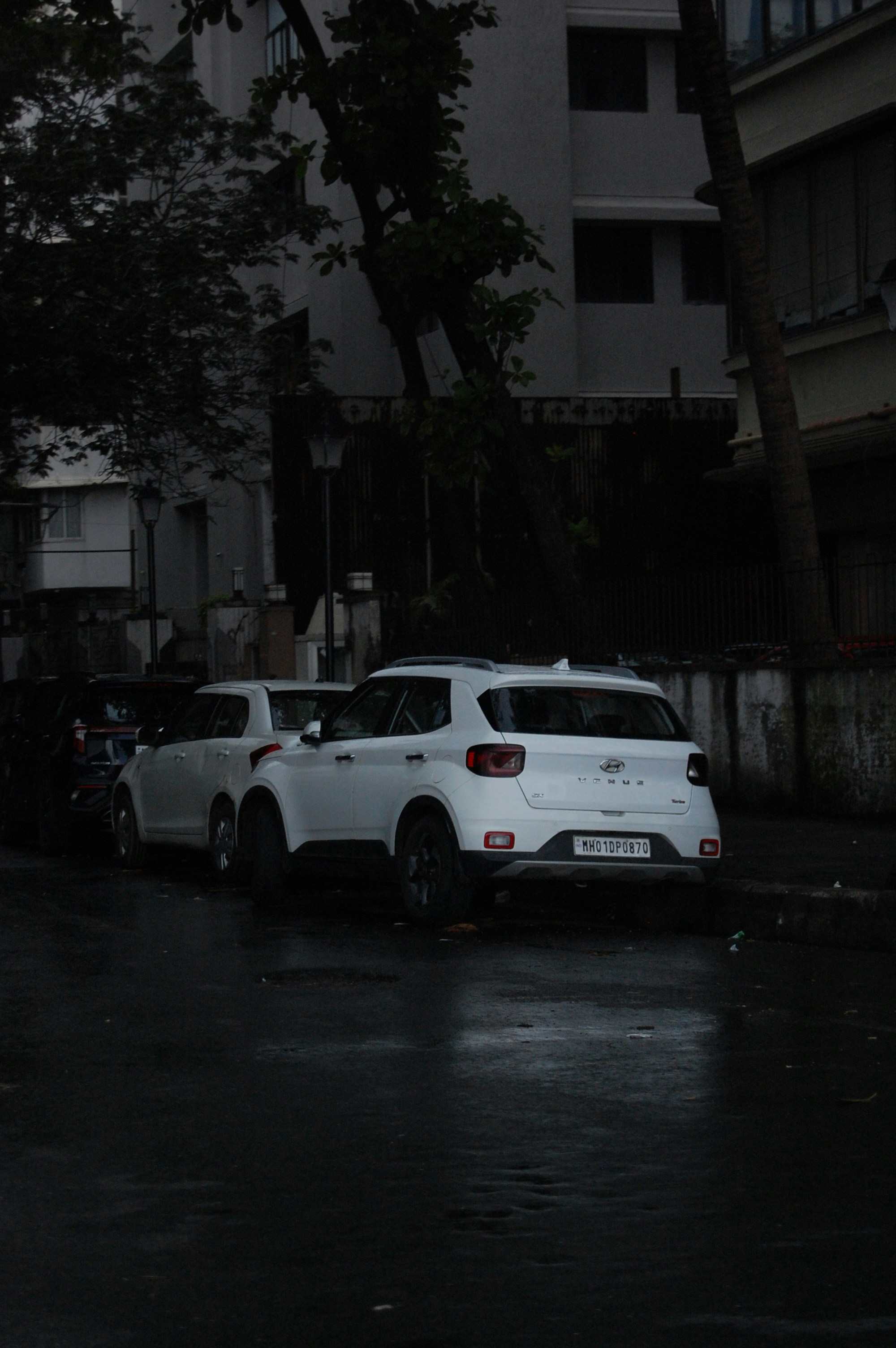 A White car with a dark background, highlighting the cars shape.