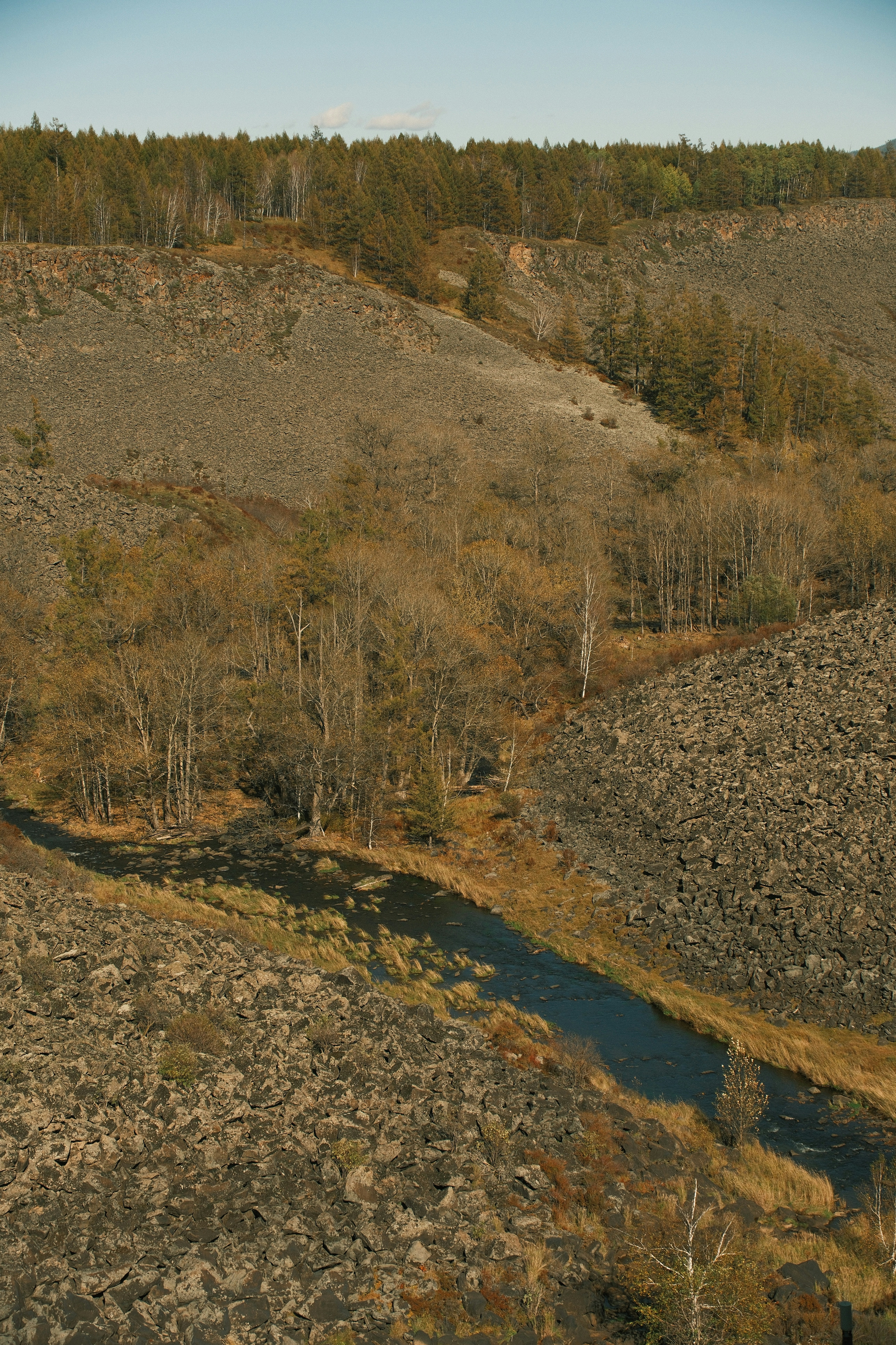 River Bend Through a Rugged Quarry Landscape in Autumn Light