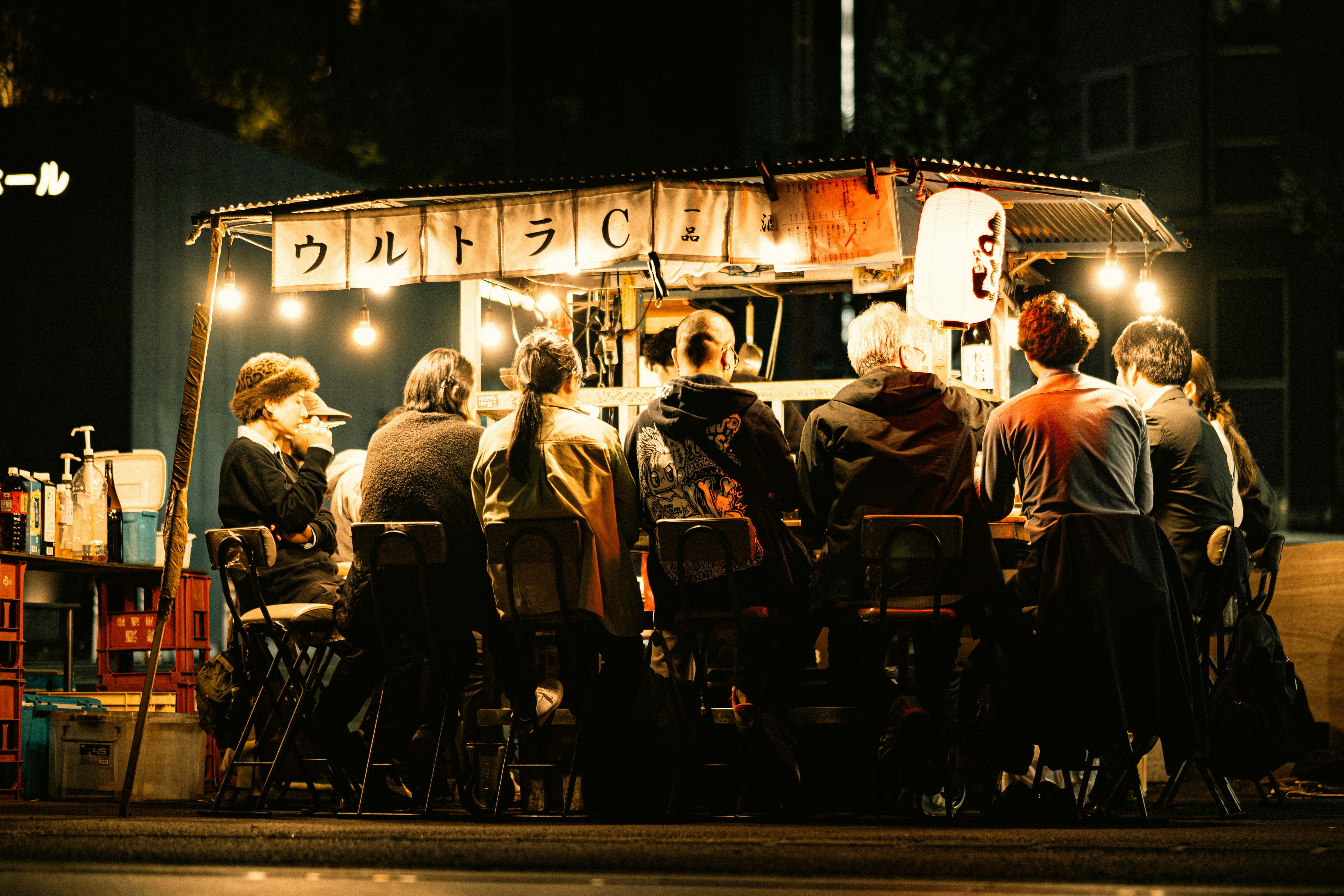 Lantern-lit Conversations at a Night Market Stall