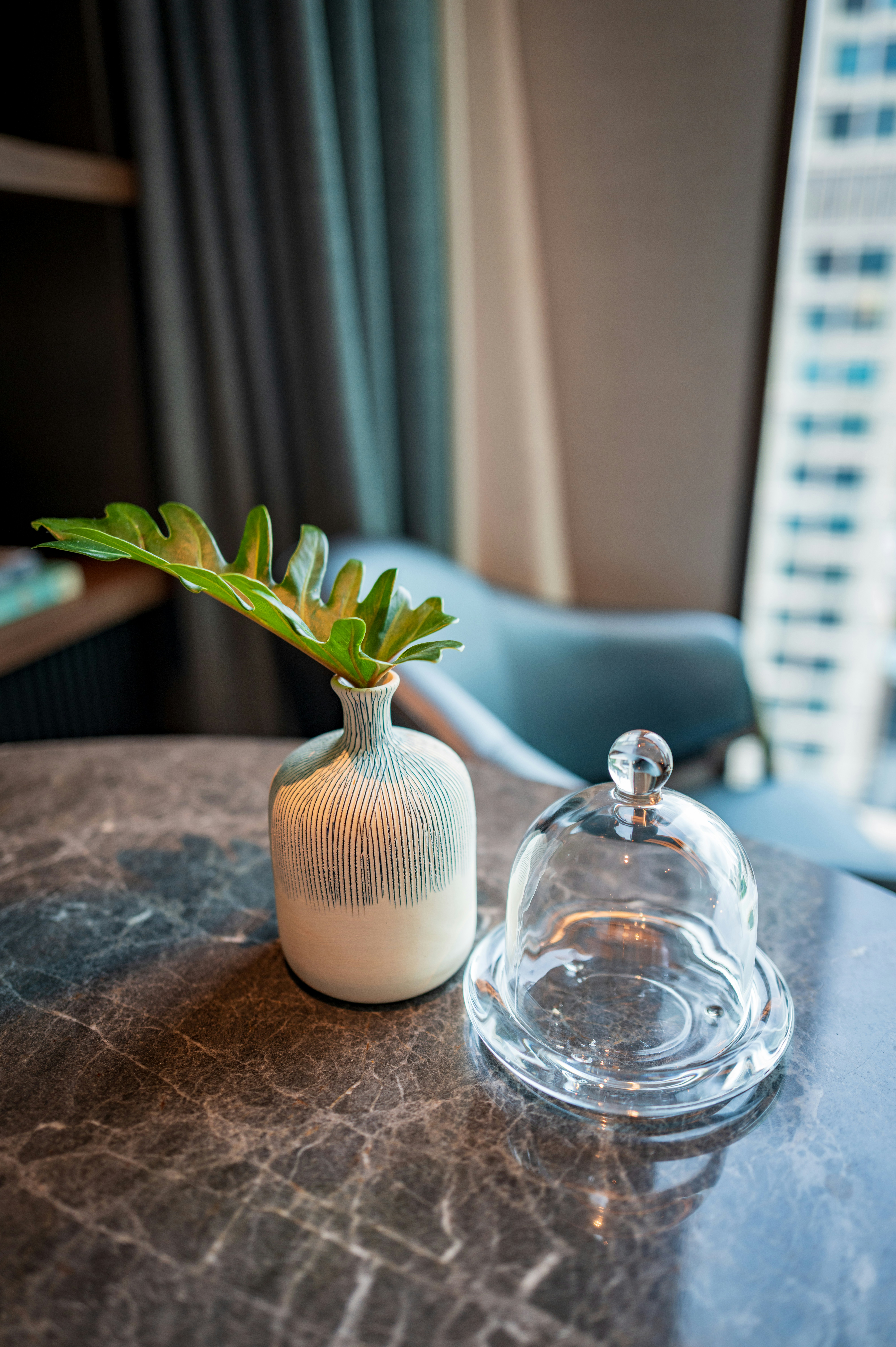 Verdant Sprig in a Striated Vase: Quiet Morning Light on Marble Table