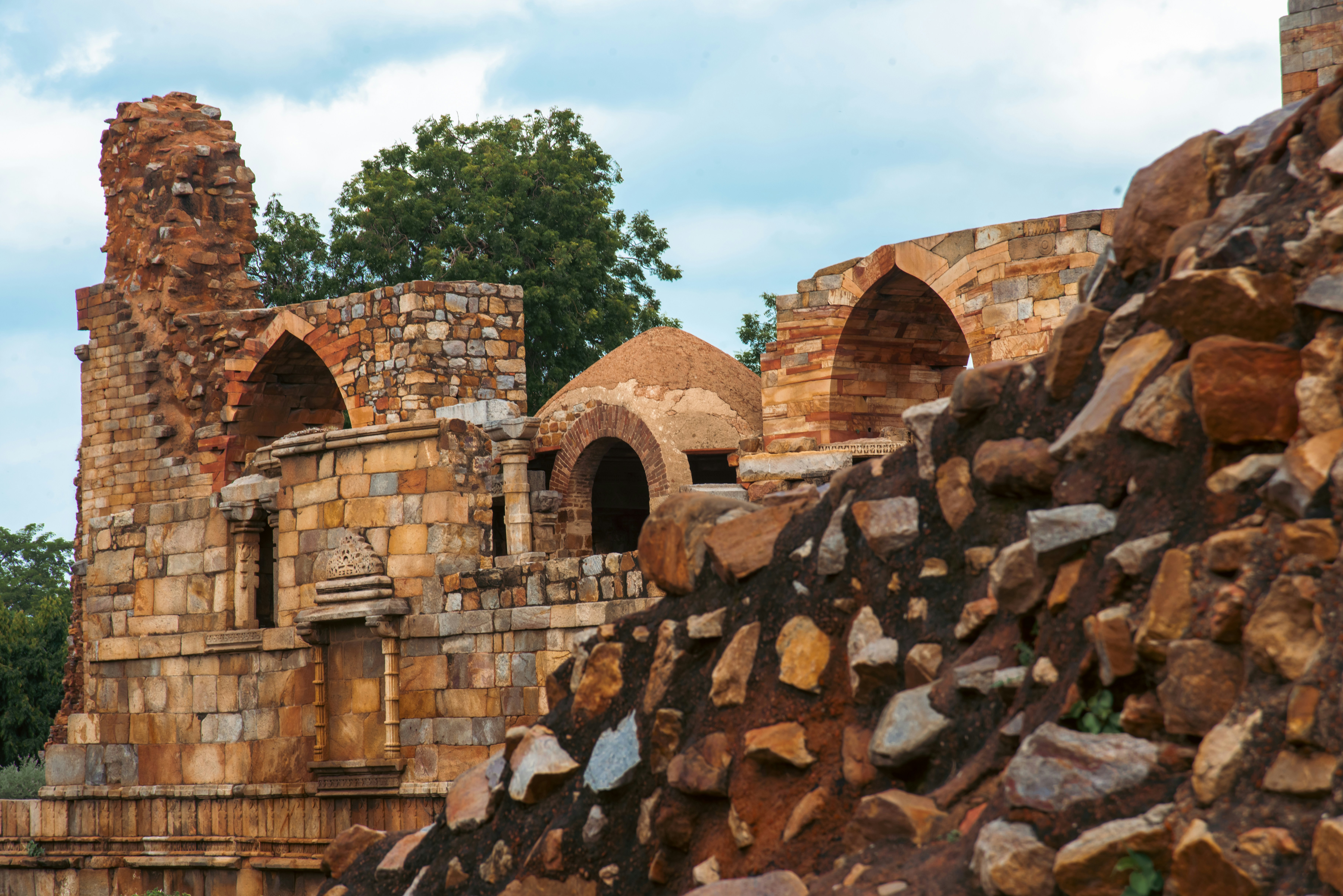 Arched Ruins in the Sun: Time-Worn Fortress Framed by Rugged Forecourt