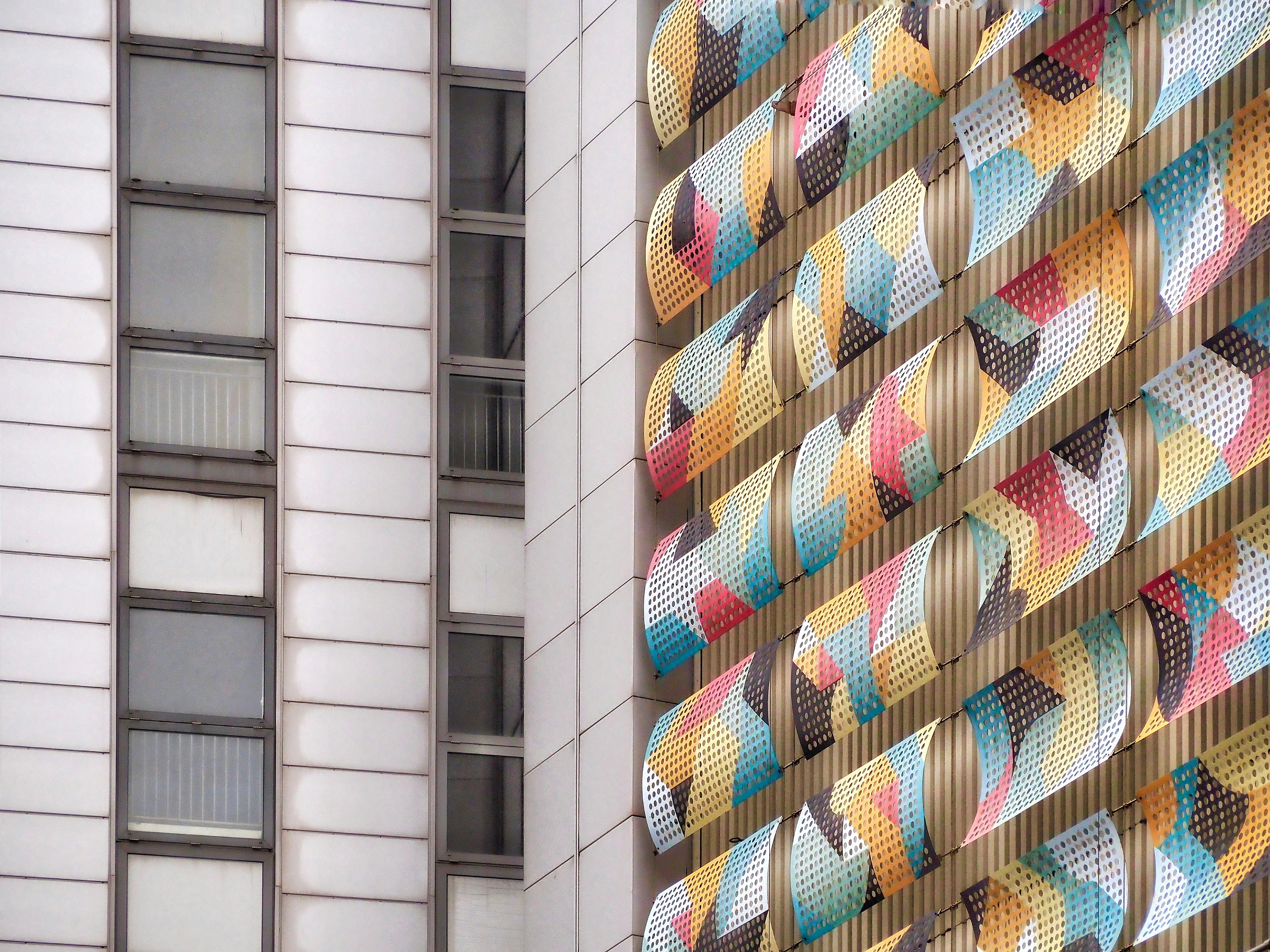 Spectrum Waves on a Facade: Curved Perforated Panels in Urban Light