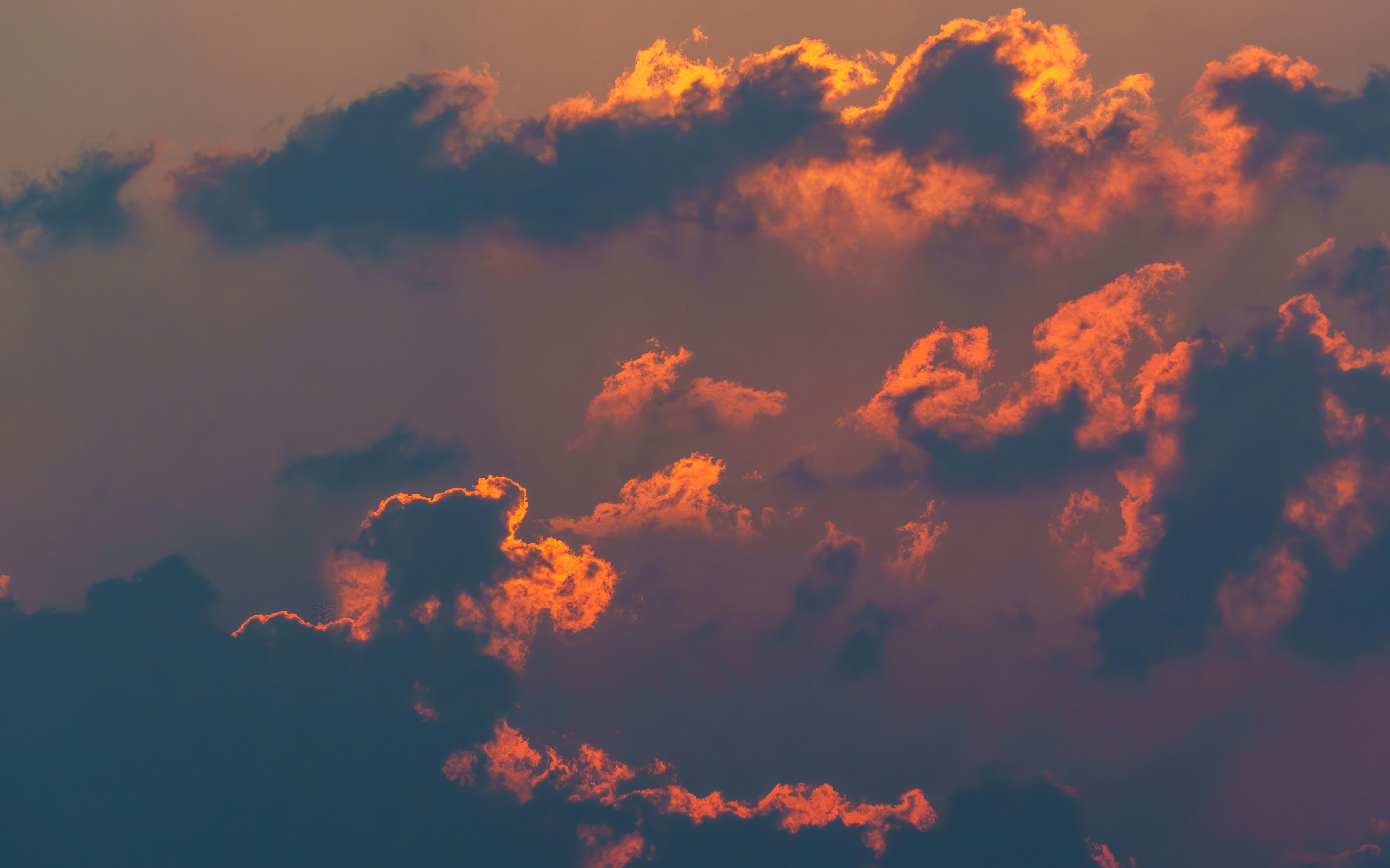 Crimson Edges of Evening: Clouds Carved in Warm Twilight