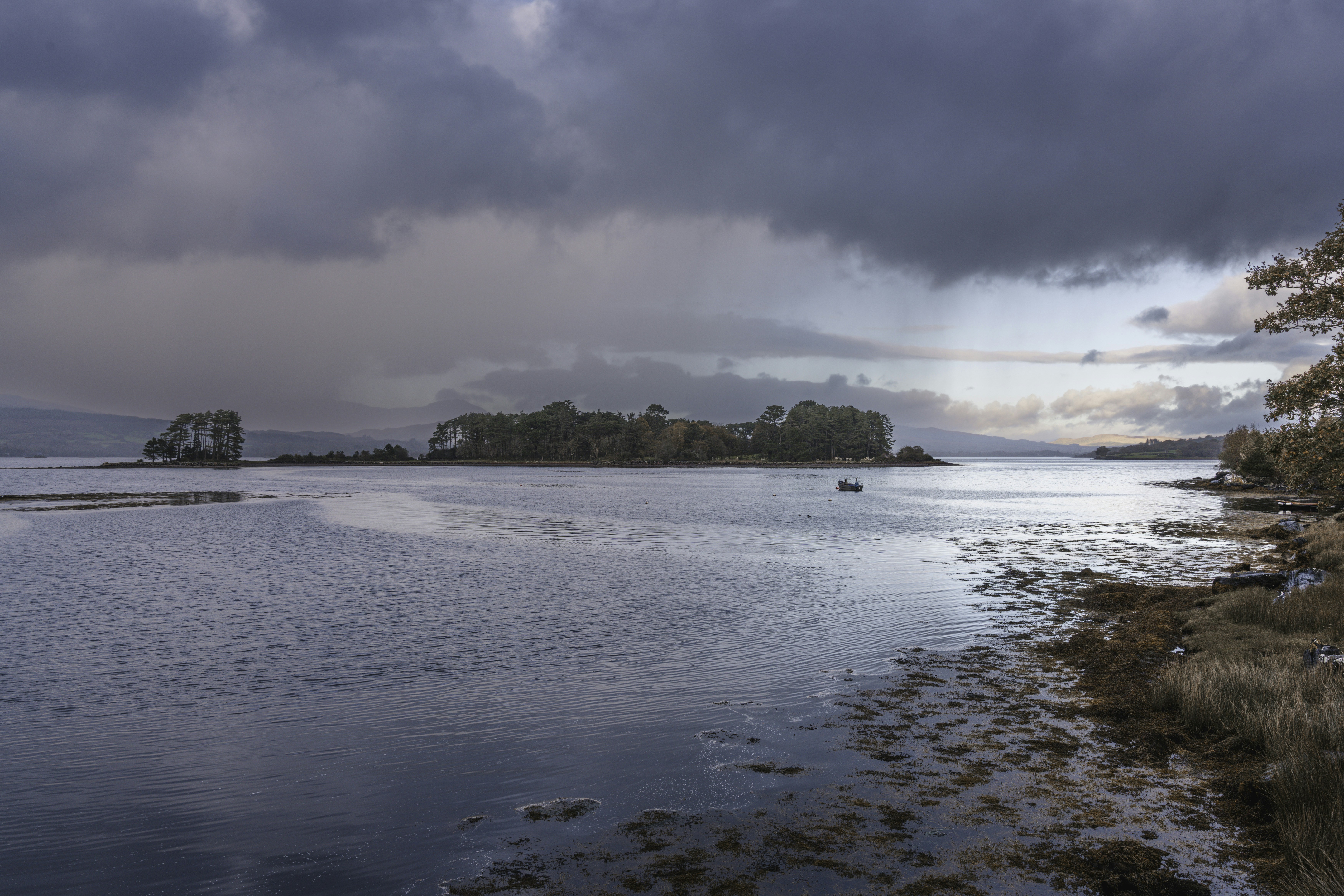 Calm shoreline under a brooding sky on a coastal inlet