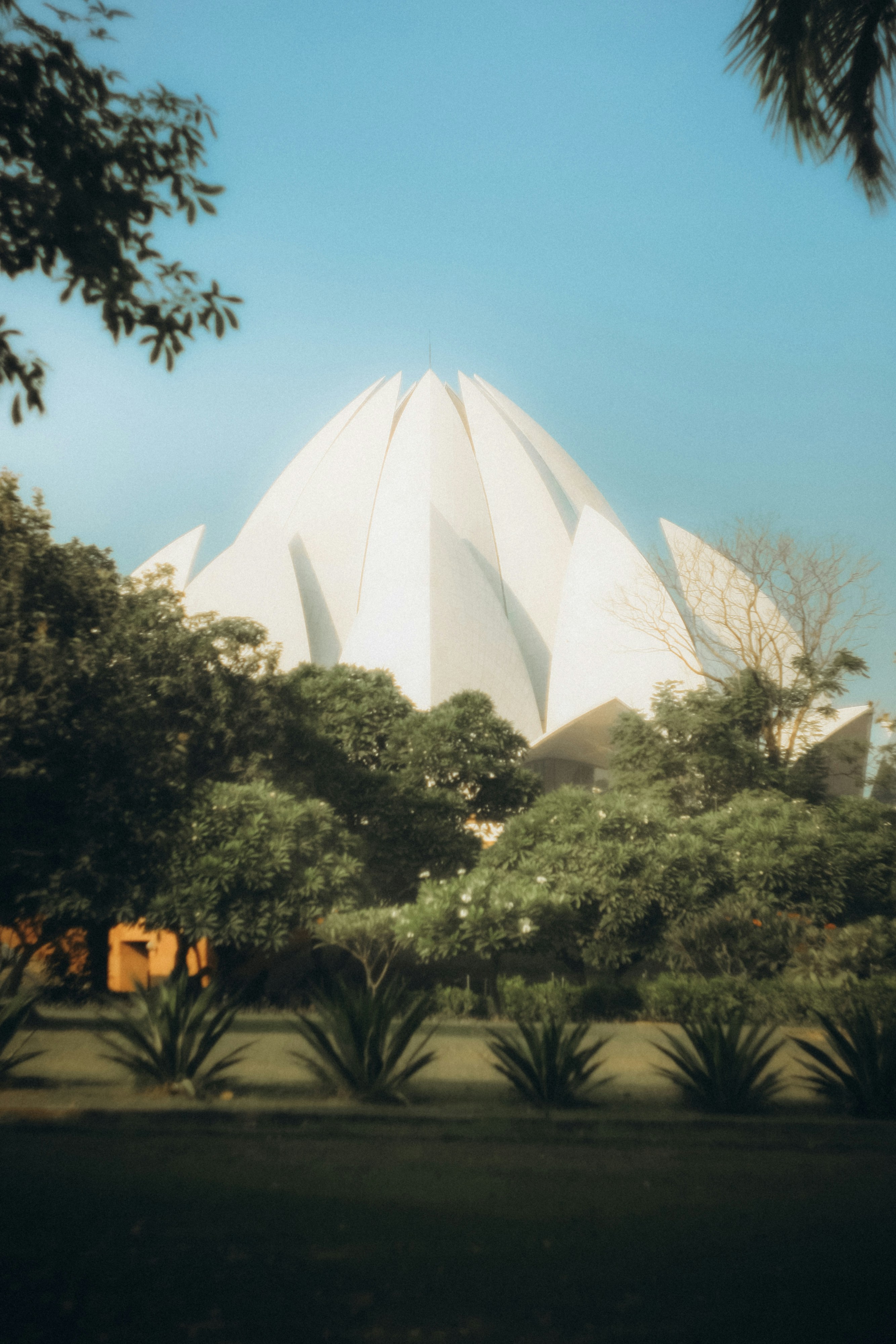 Deserted Cathedral of Light: White Geometric Facade in a Quiet Park