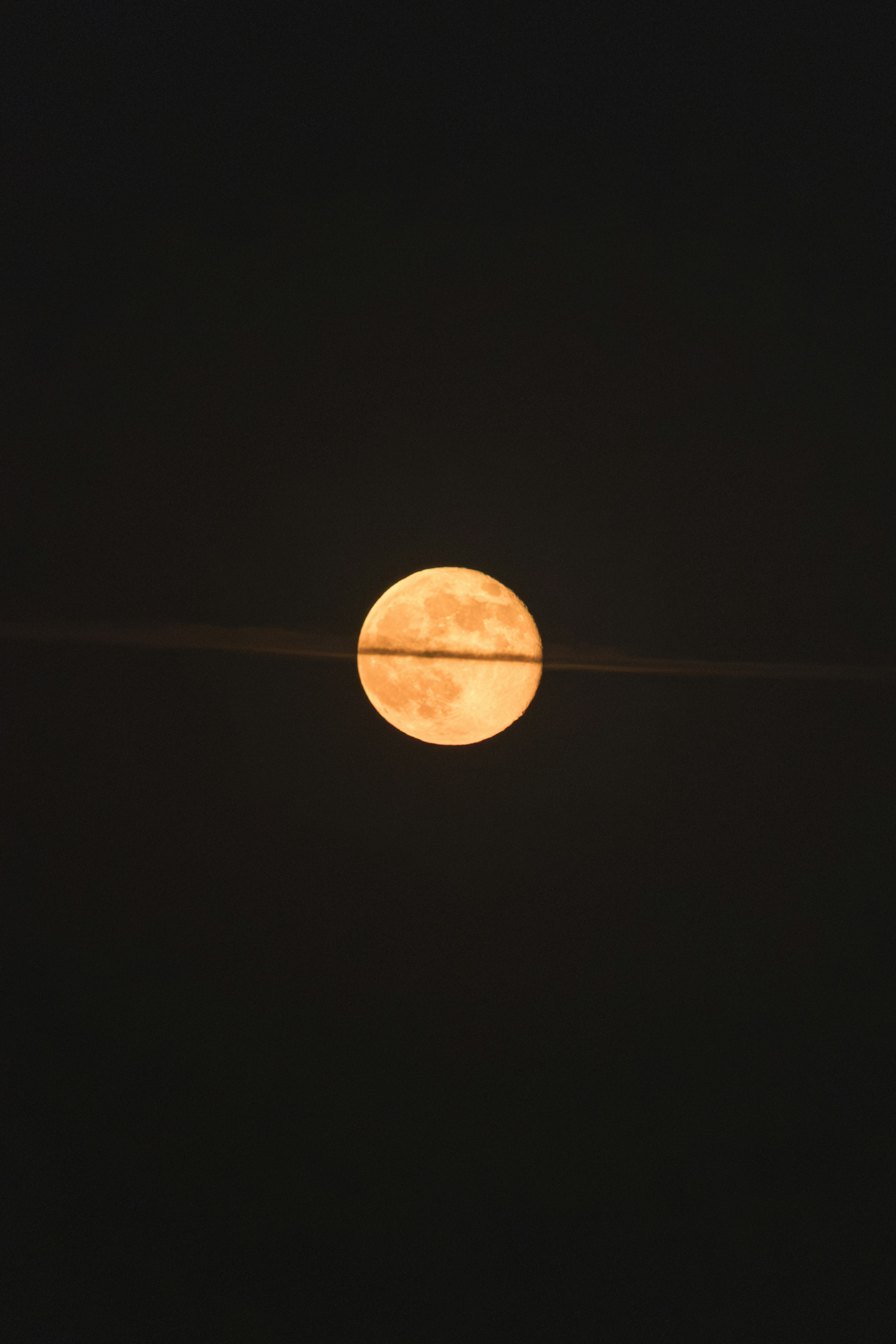 Copper Moon Pierced by a Thin Horizon Line