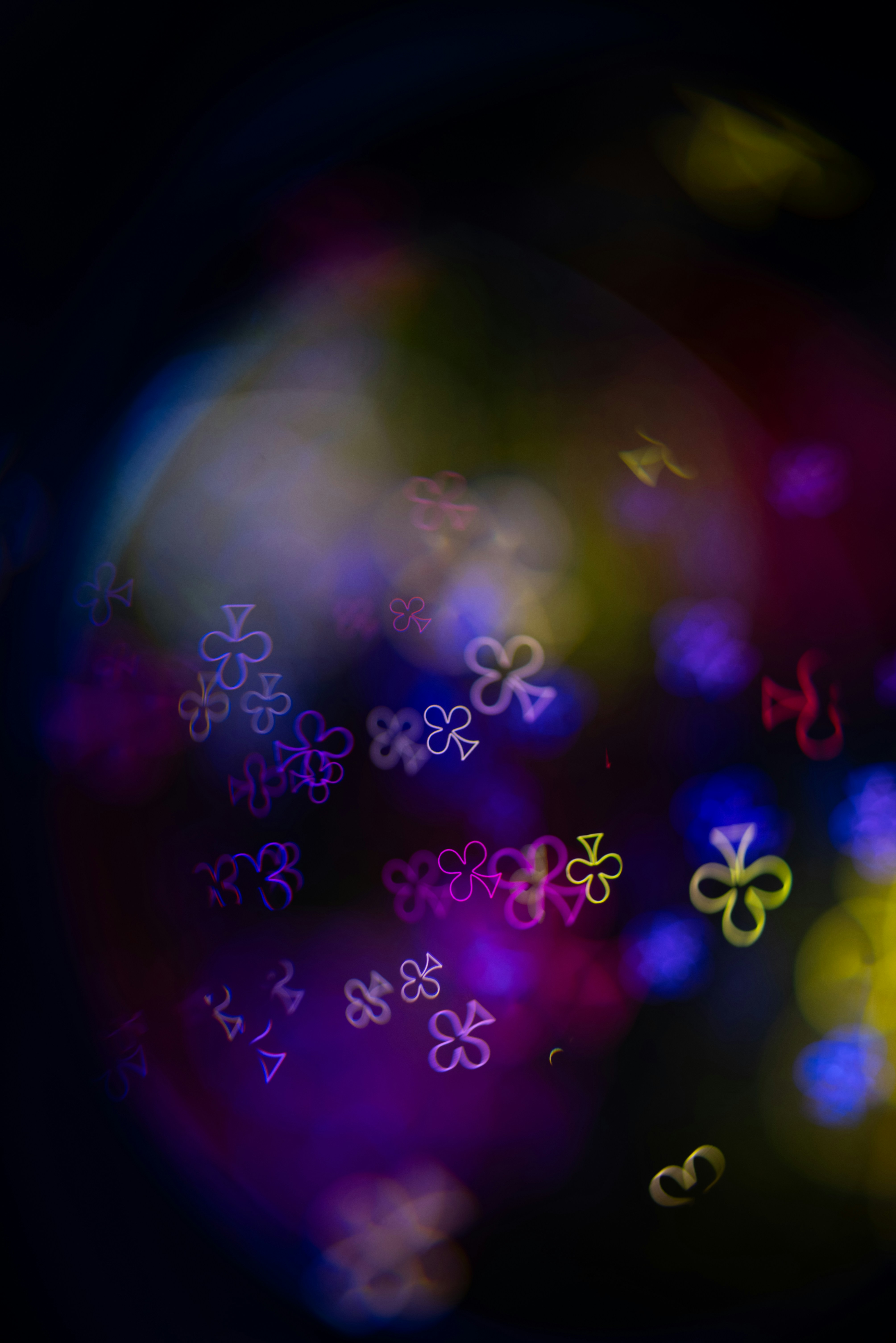 Neon Clover Bokeh: Floating Petal Orbs in a Velvet Night