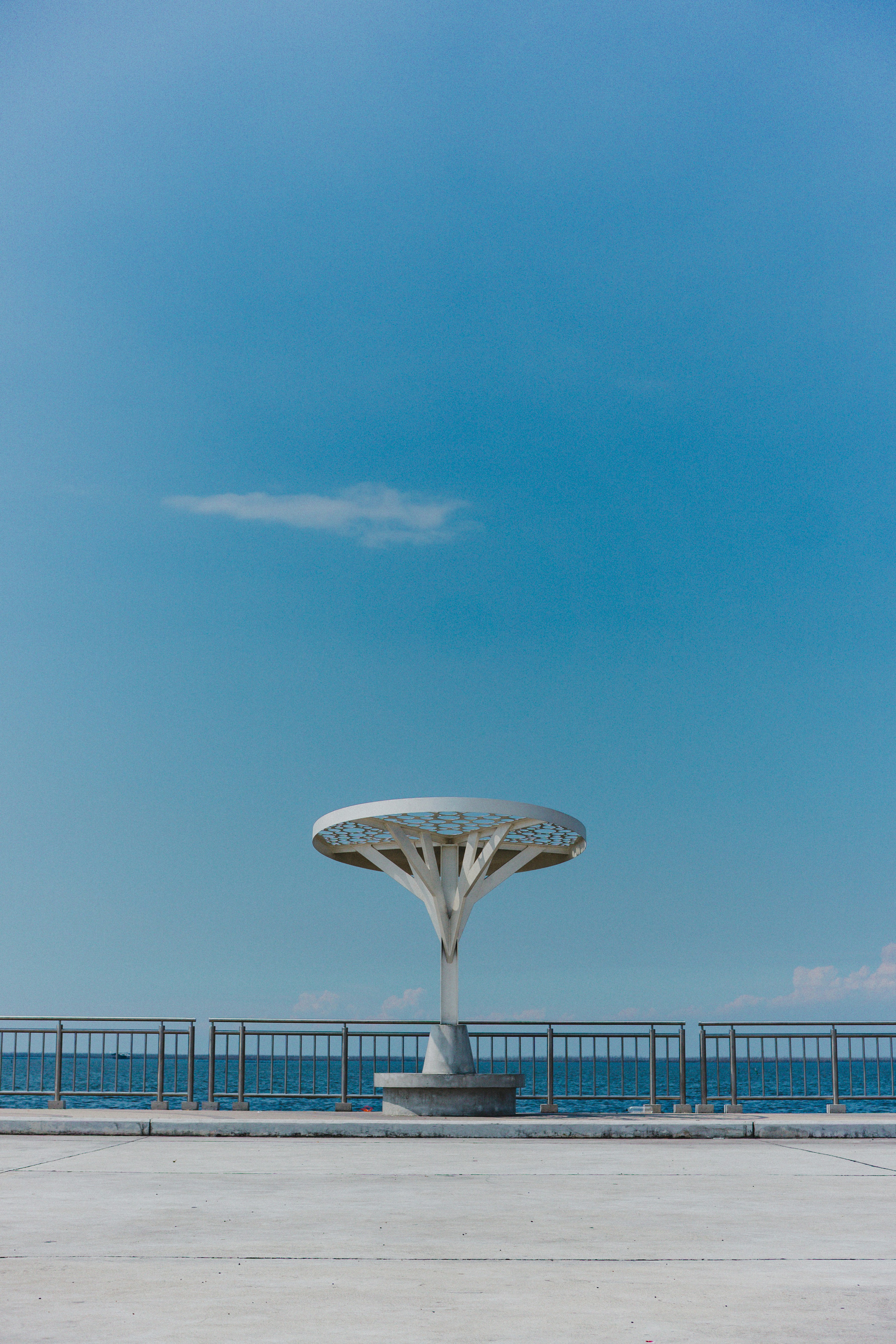Circular Canopy at the Horizon: A Minimalist Seaside Sculpture by the Pier
