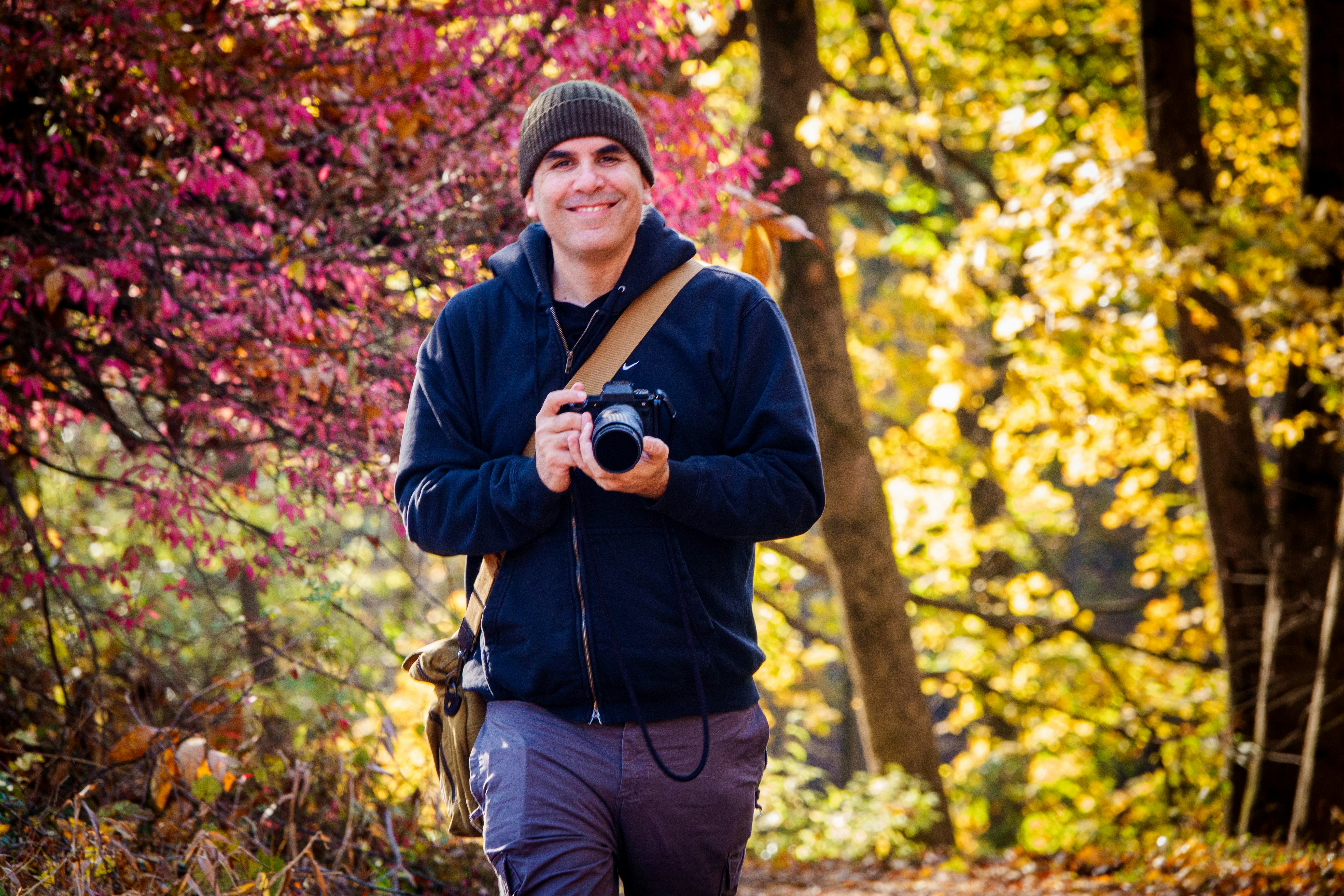 Amber Hour Portrait: A photographer capturing light amid autumn gold