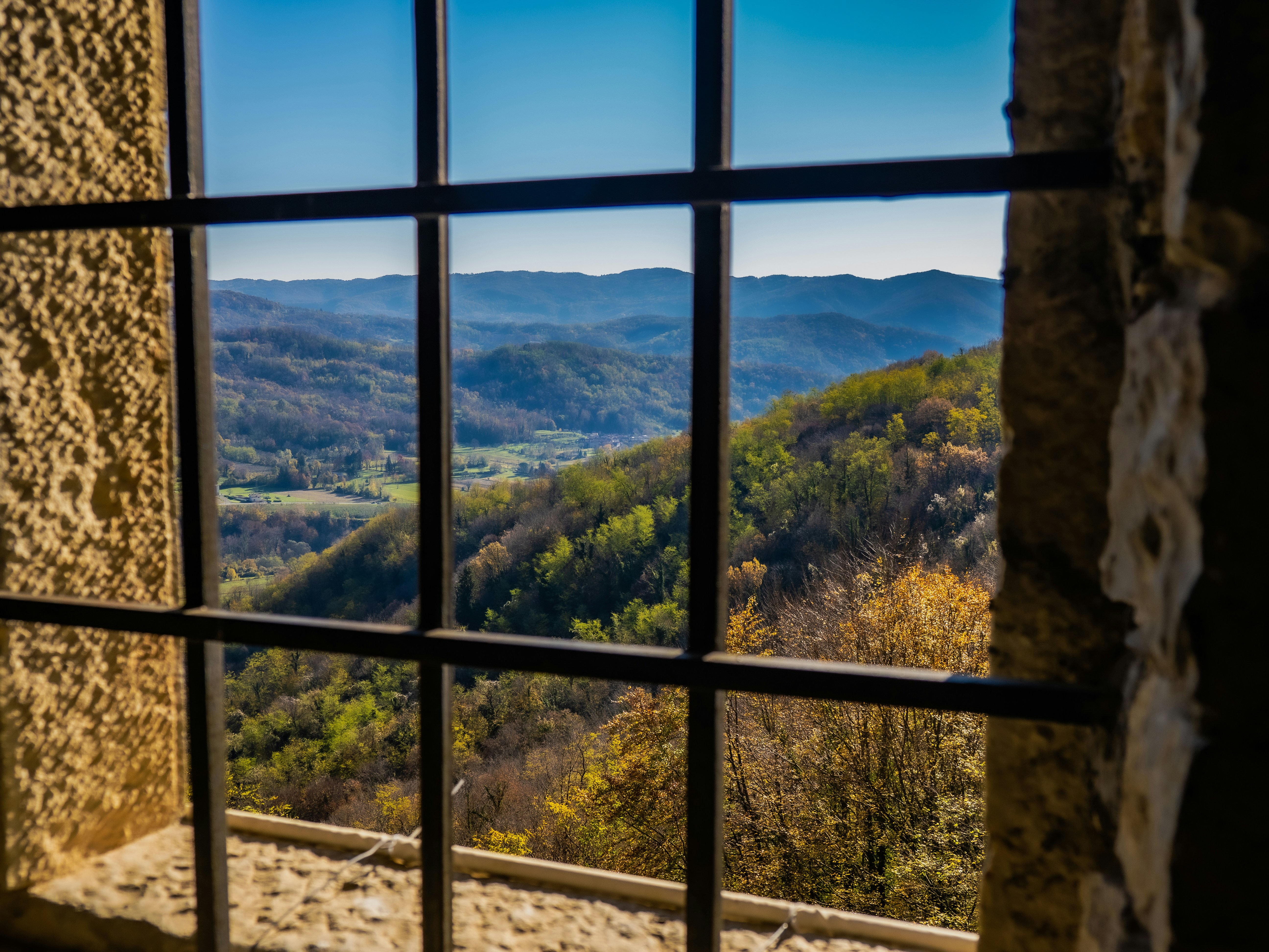 View through Iron Bars: Valley Vistas Beyond a Fortress Window