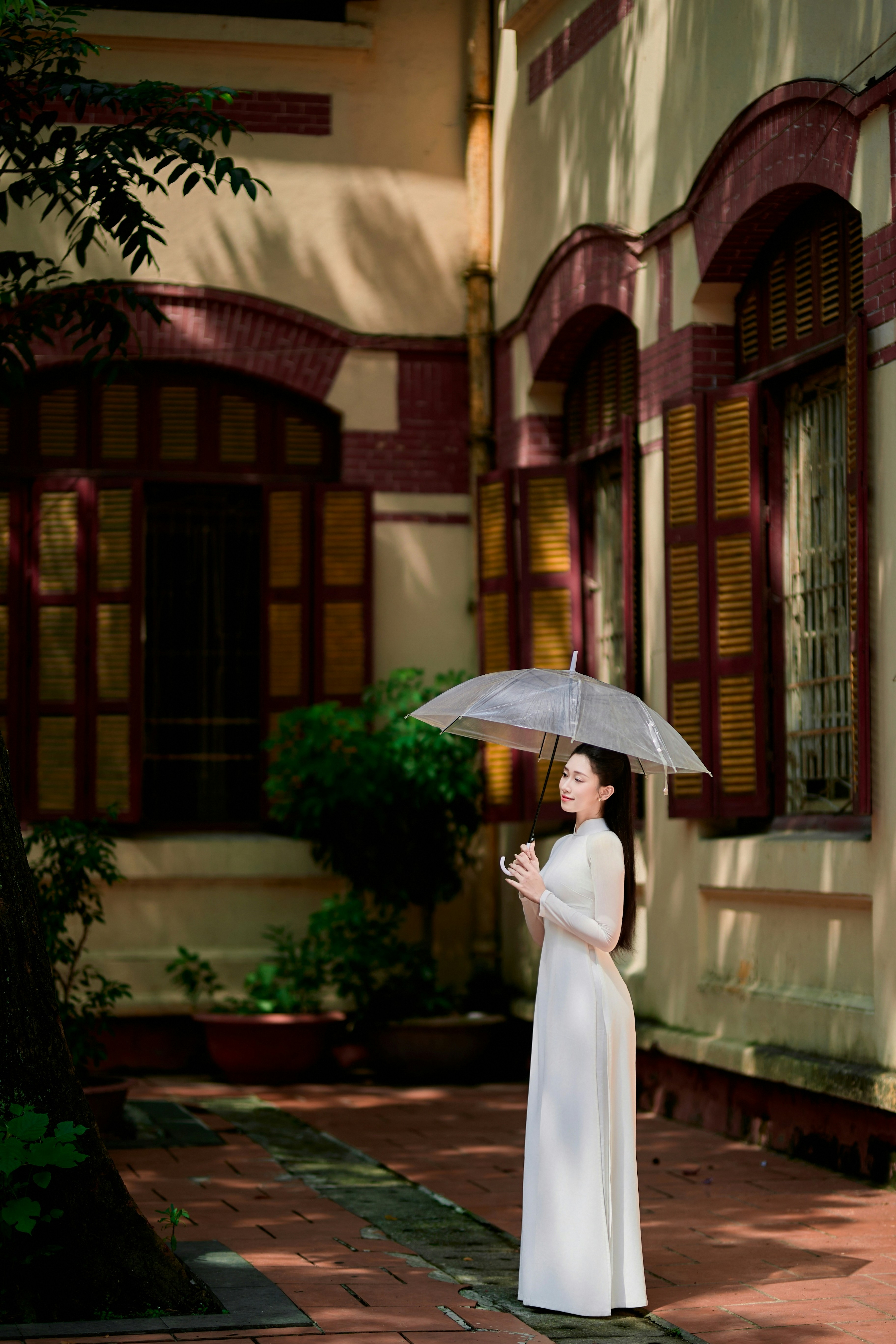 Umbrella in the Courtyard: A Quiet Portrait Under Soft Shadows
