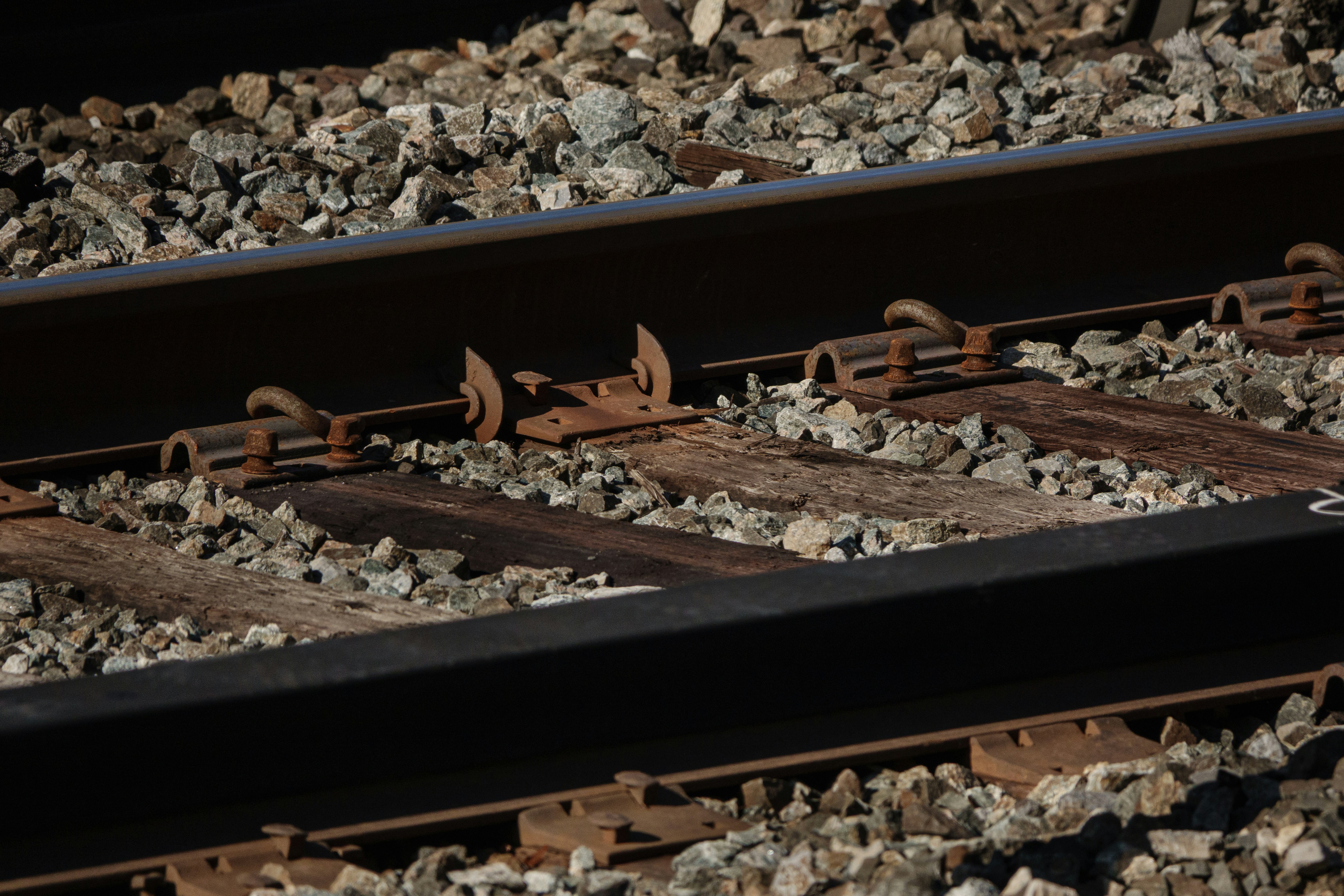Close-up view of rusty train tracks and gravel. photo – Free Wood Image ...