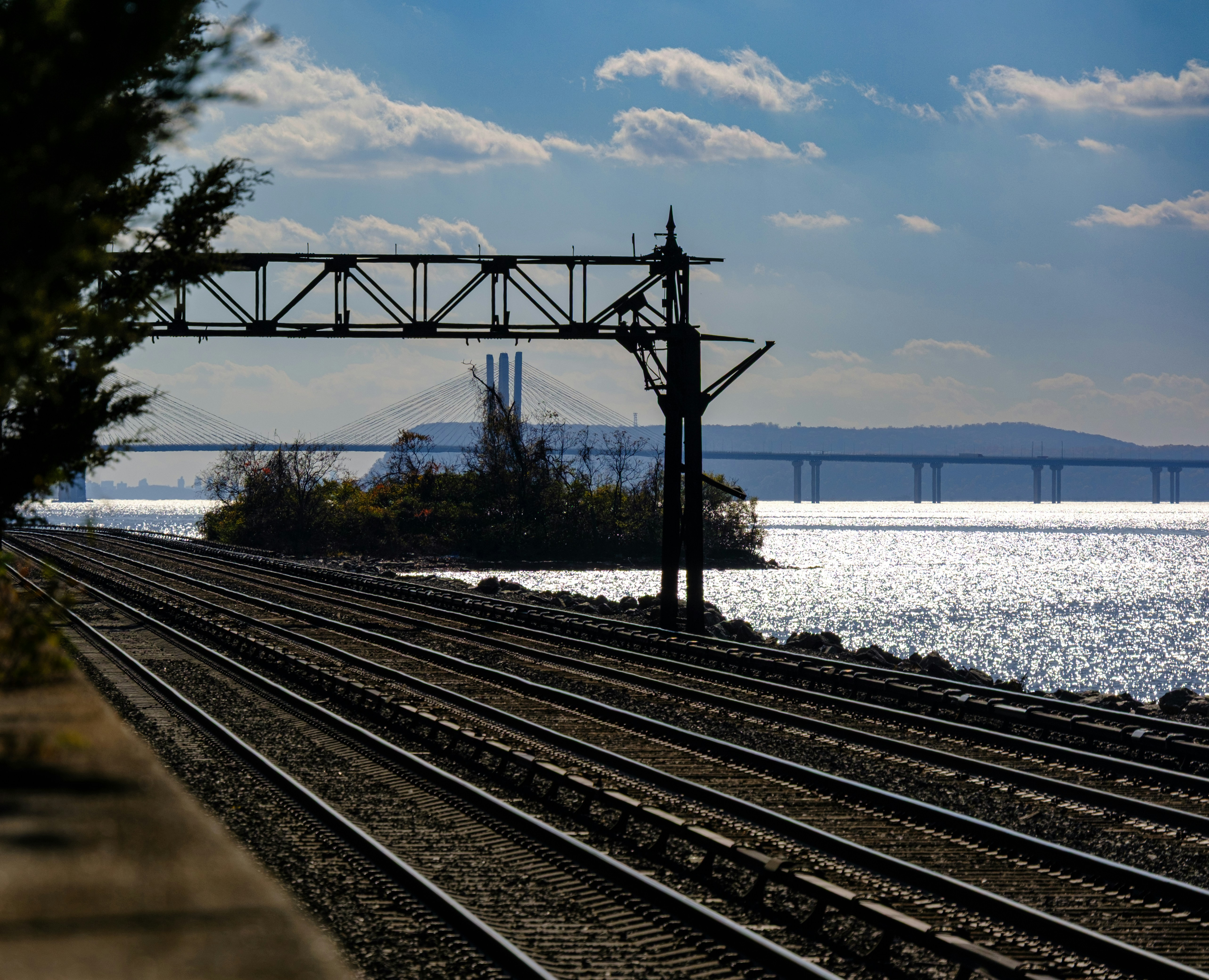 Gantry and Rails: Converging Lines Toward a Distant Bridge over Shimmering Water
