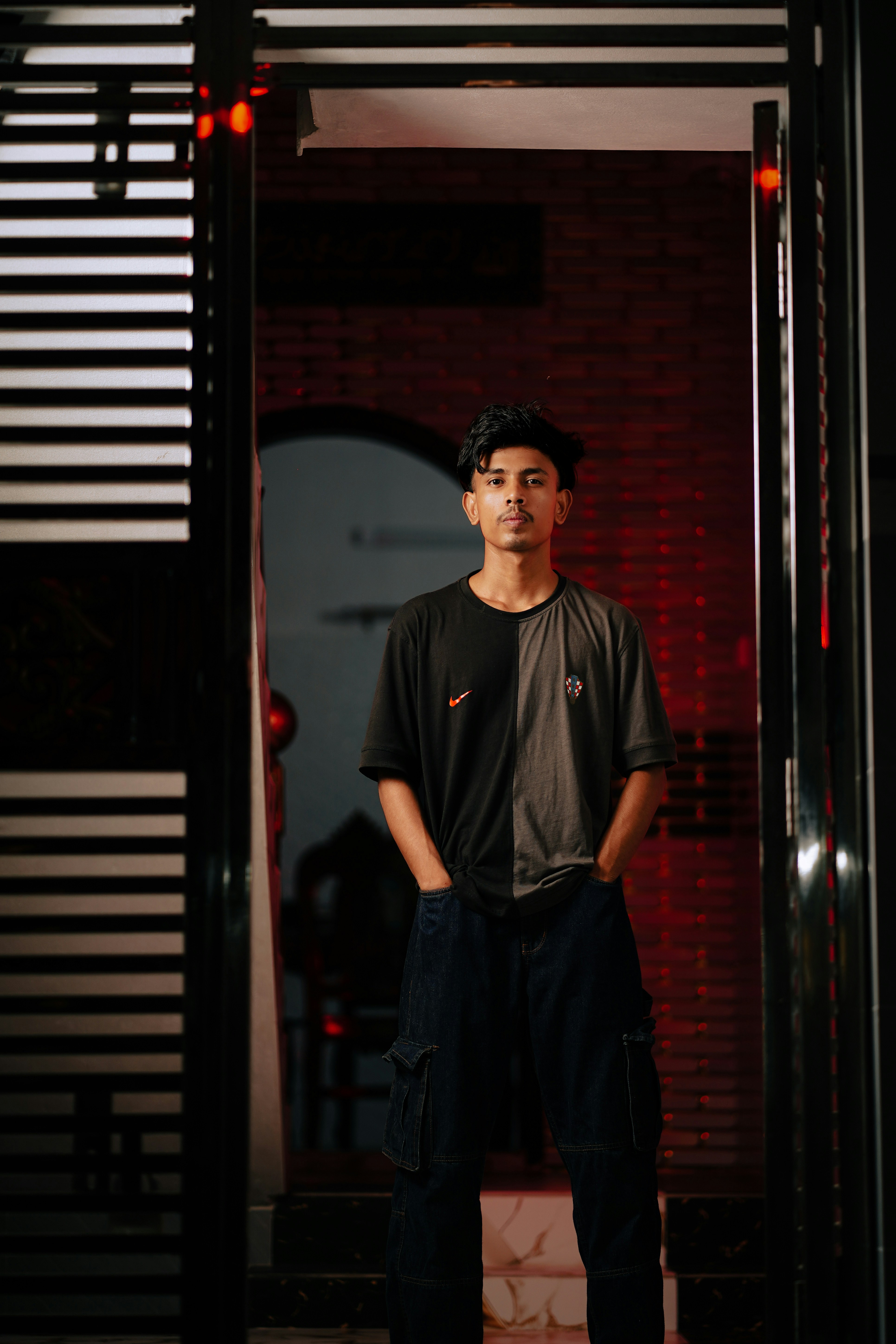 Crimson Threshold: A Quiet Portrait in an Industrial Entrance