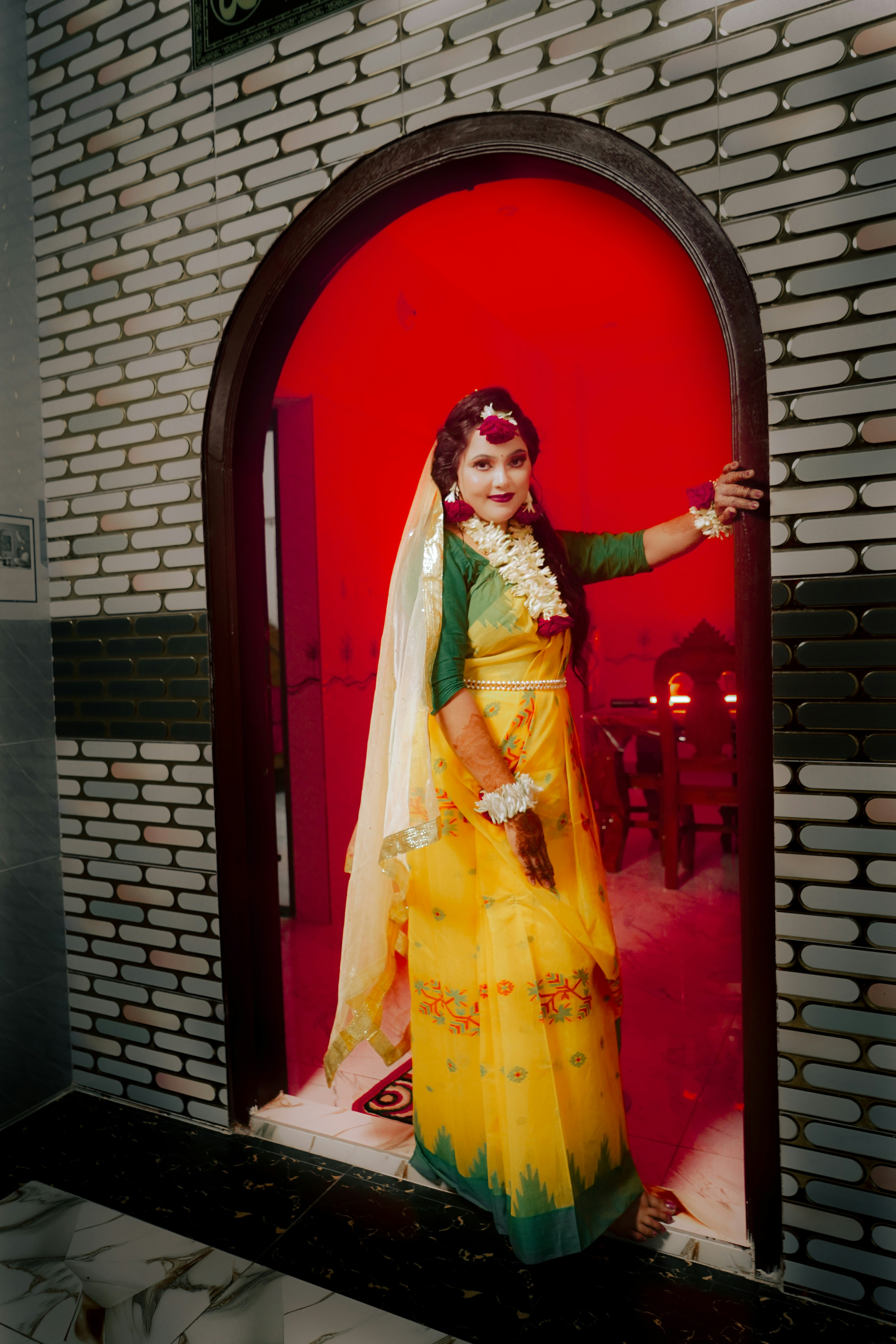 Golden Sari at a Crimson Arch: A Festive Studio Portrait