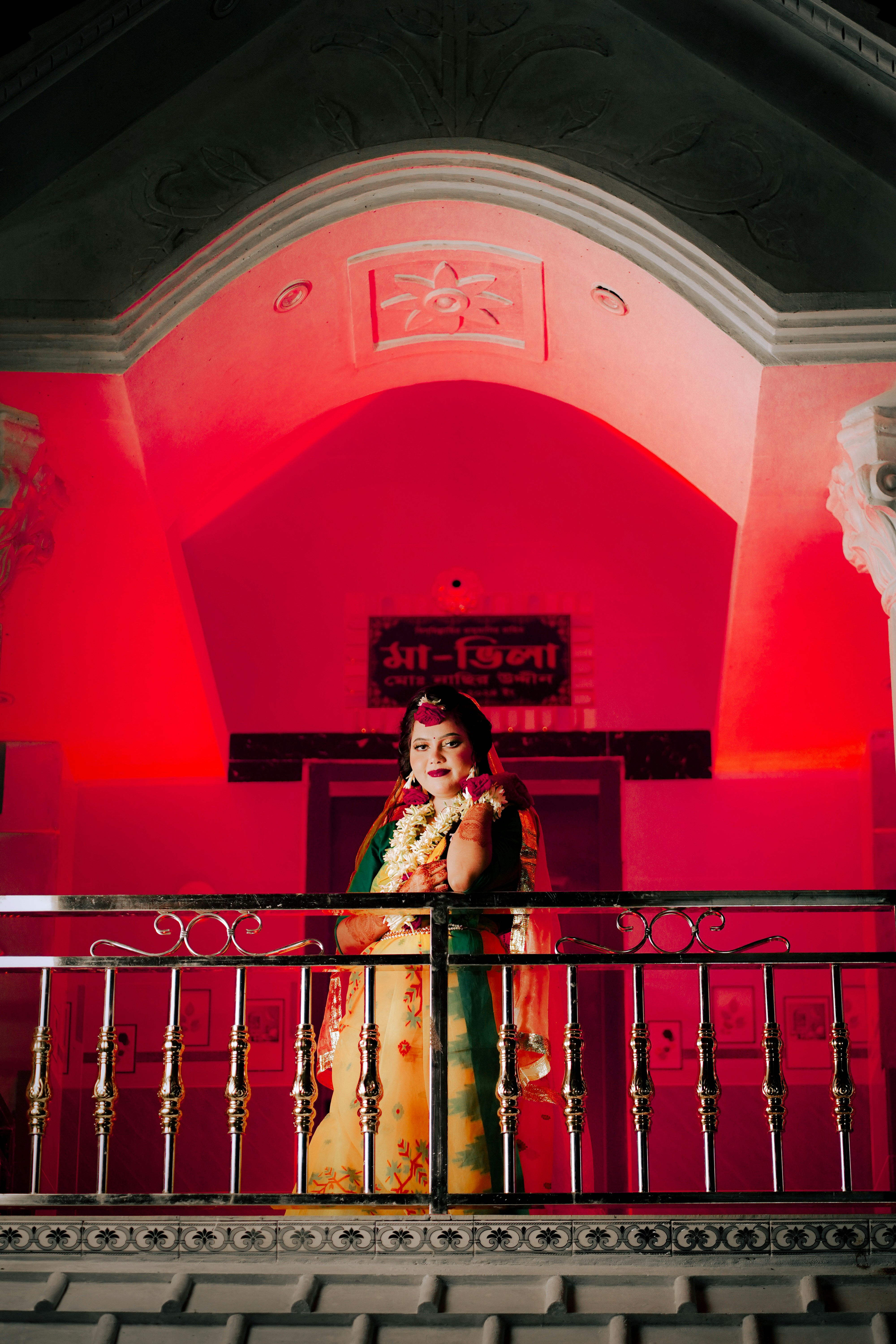 Crimson Archways and a Garlanded Bride on a Heritage Balcony