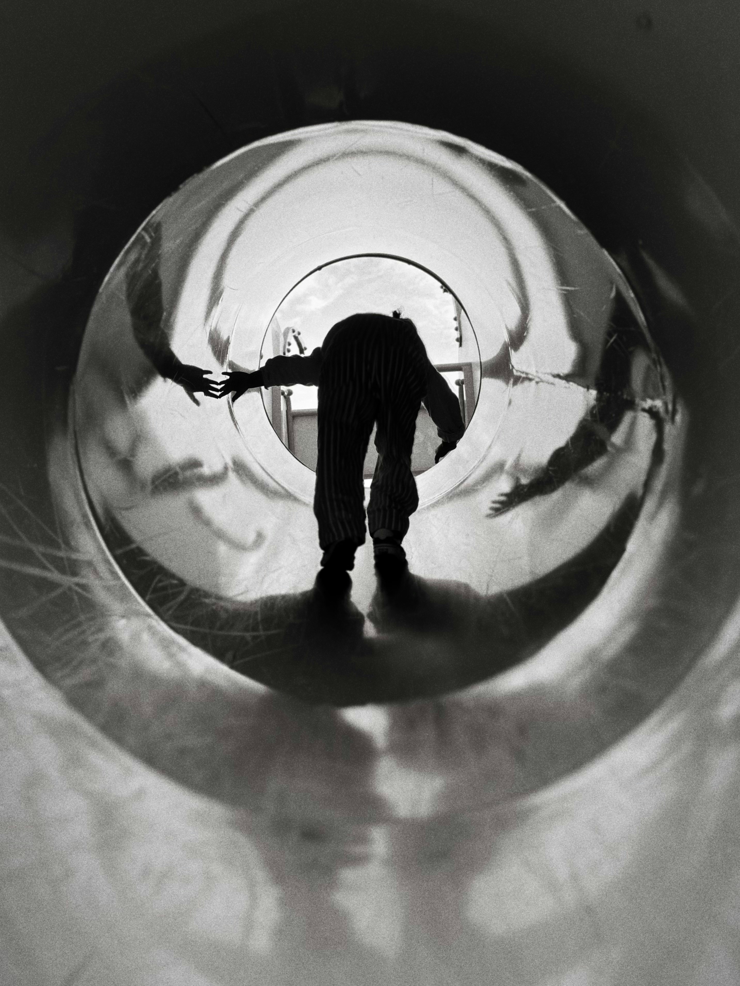 Center Ring: A Figure Reaches Through the Reflective Tunnel