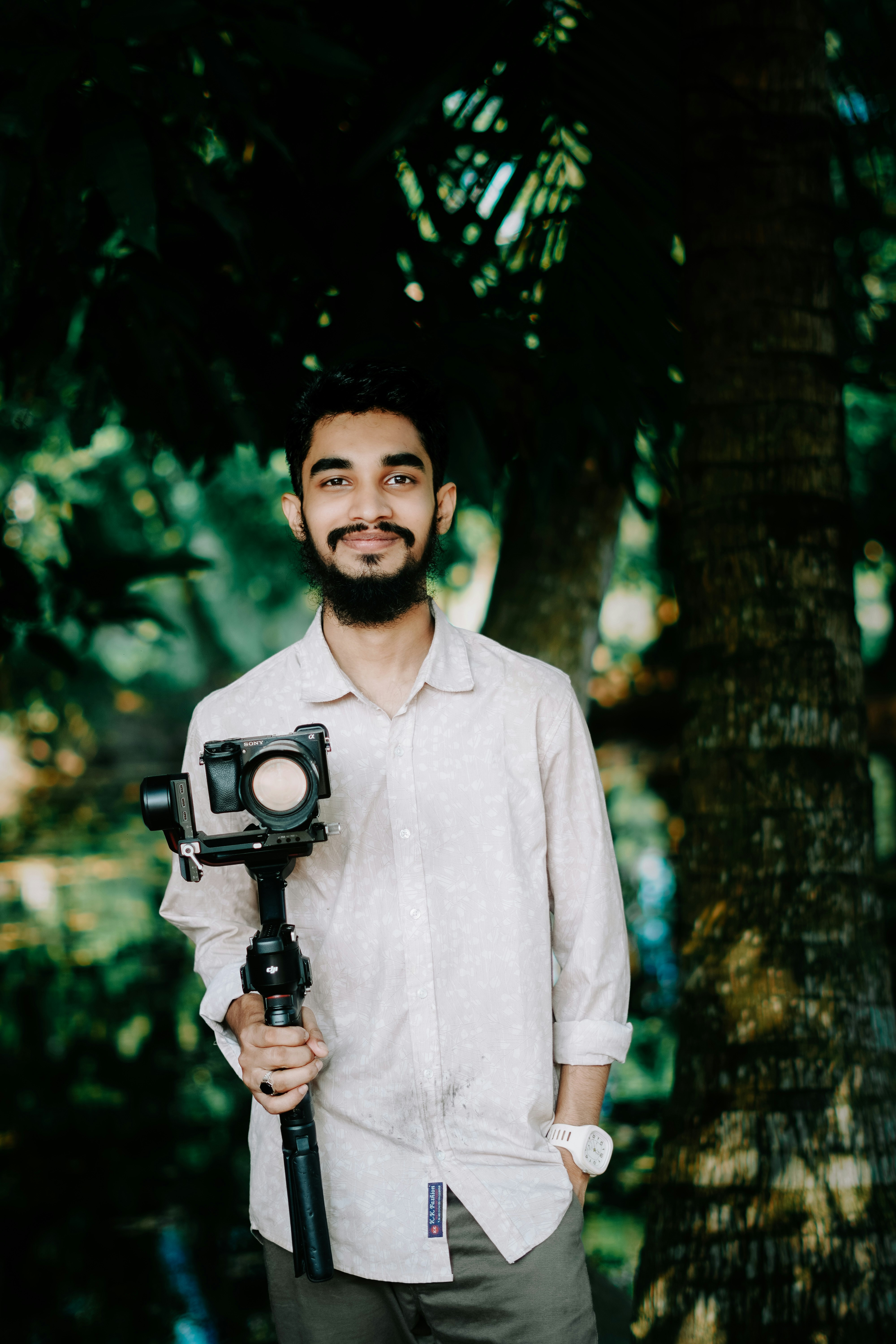 Gimbal in Hand: Portrait of Focus Under a Canopy of Palm and Light