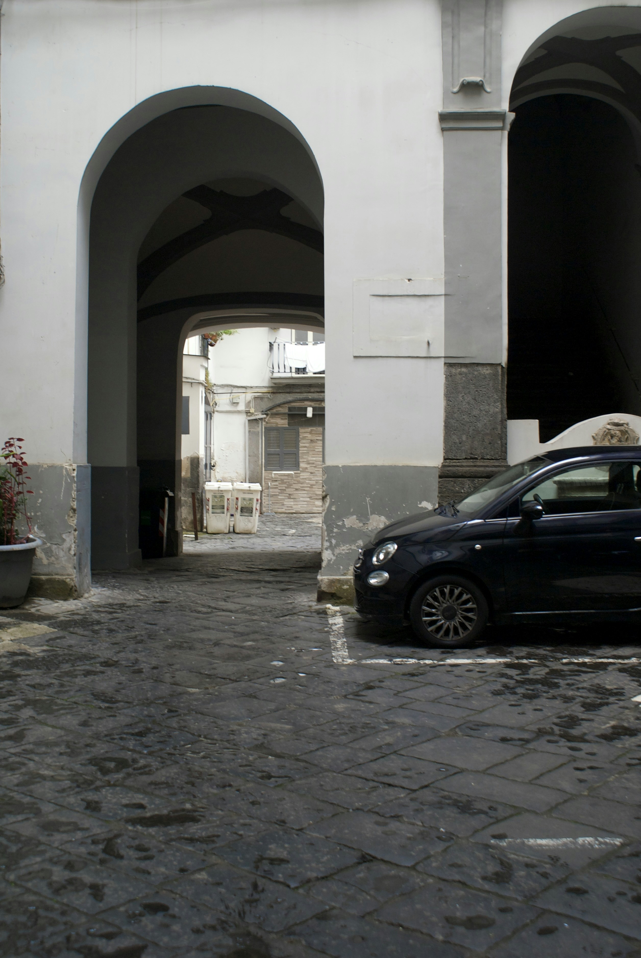 Through the Arch: A Quiet Courtyard Framed by Stone and Shadow