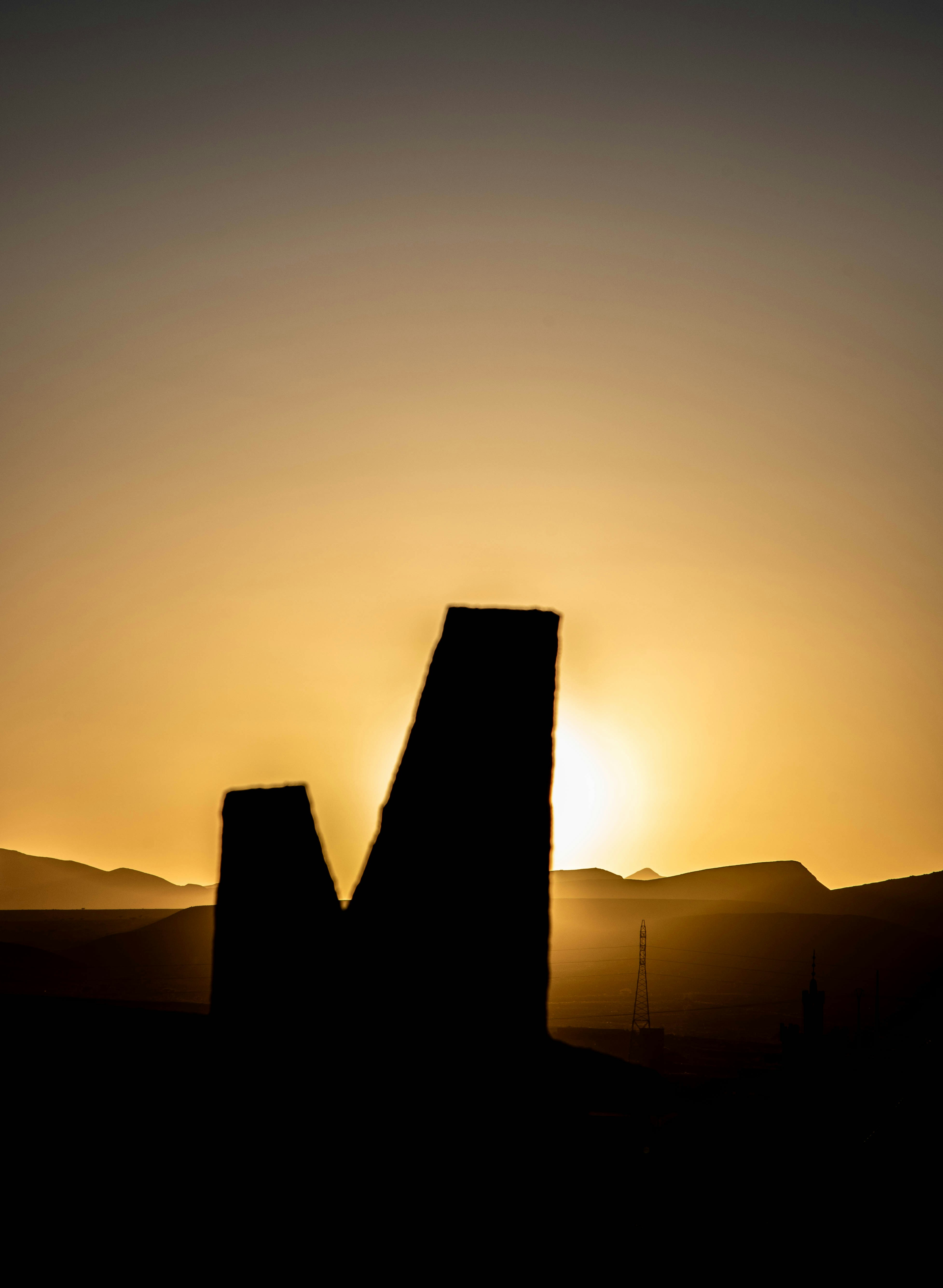 Dusk Monoliths Over a Quiet Horizon