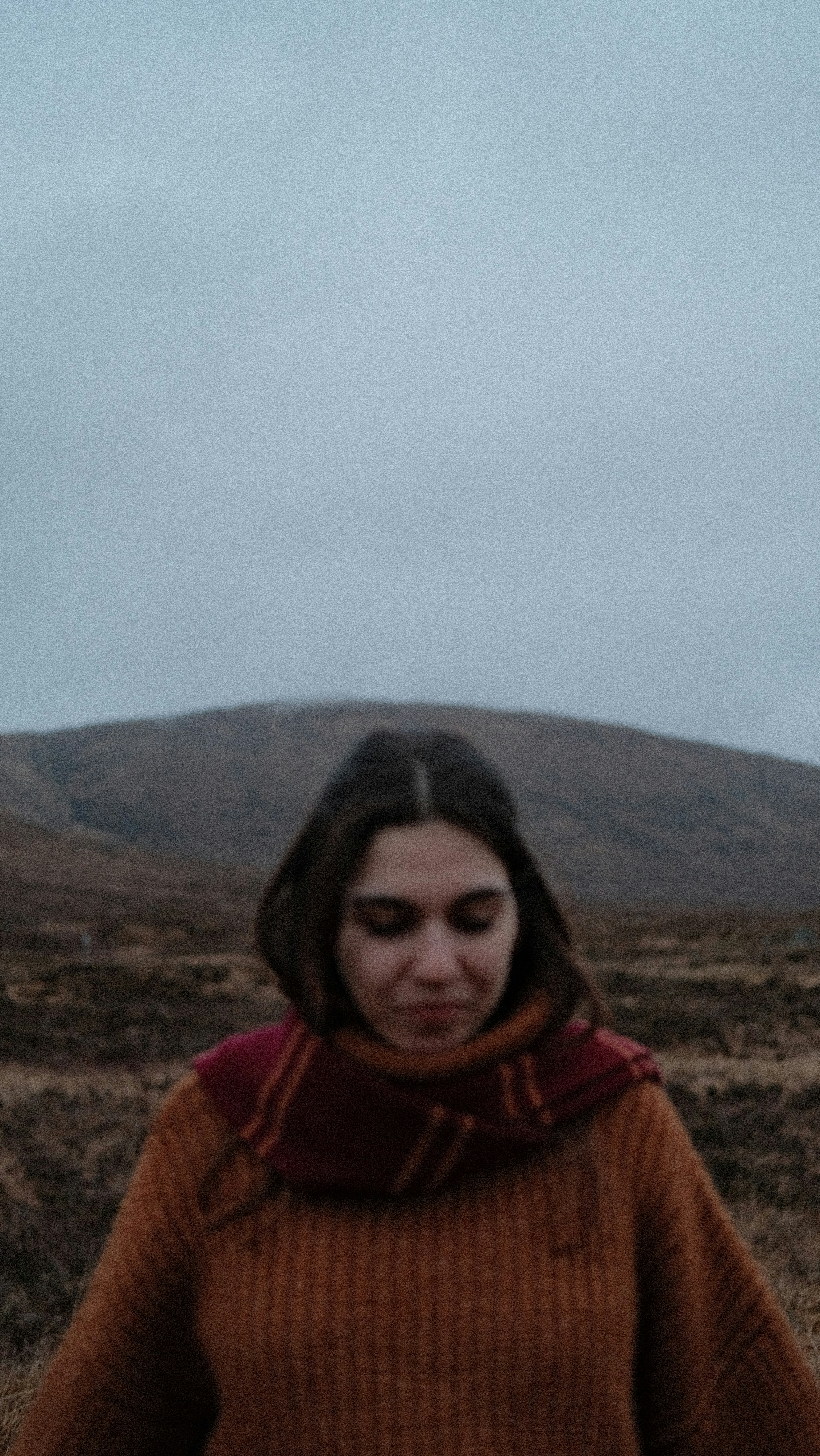 Amber Knit in the Moor: a wind-swept portrait under a clouded Highland sky
