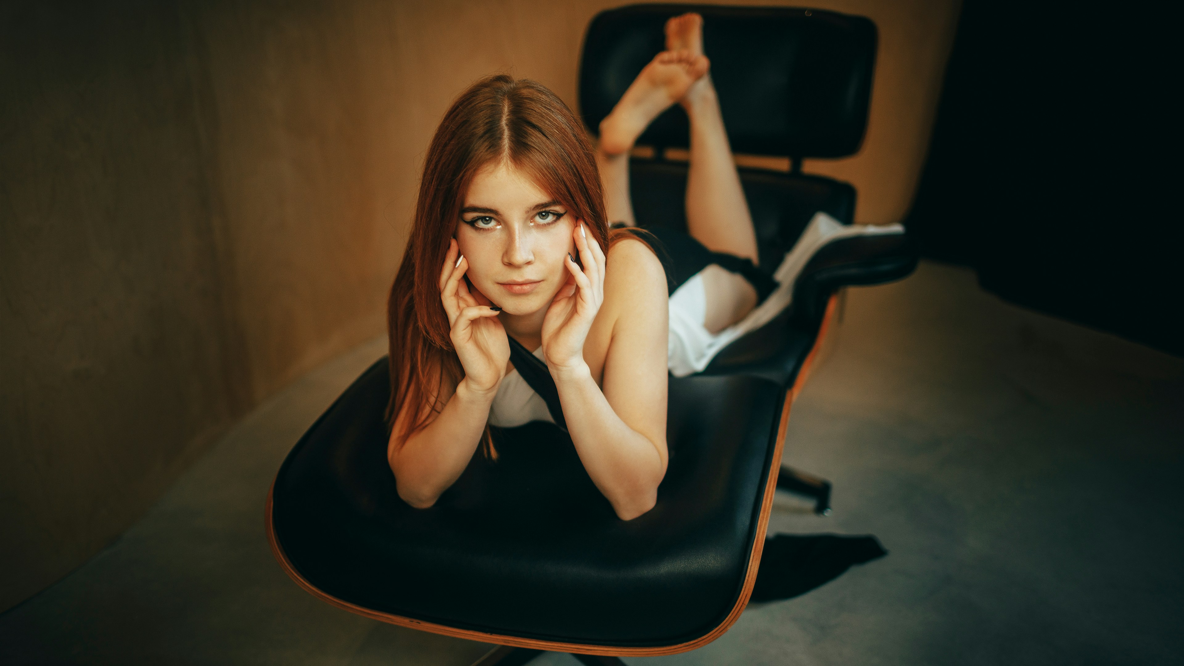Gently Lit Gaze: Studio Portrait on a Leather Lounge
