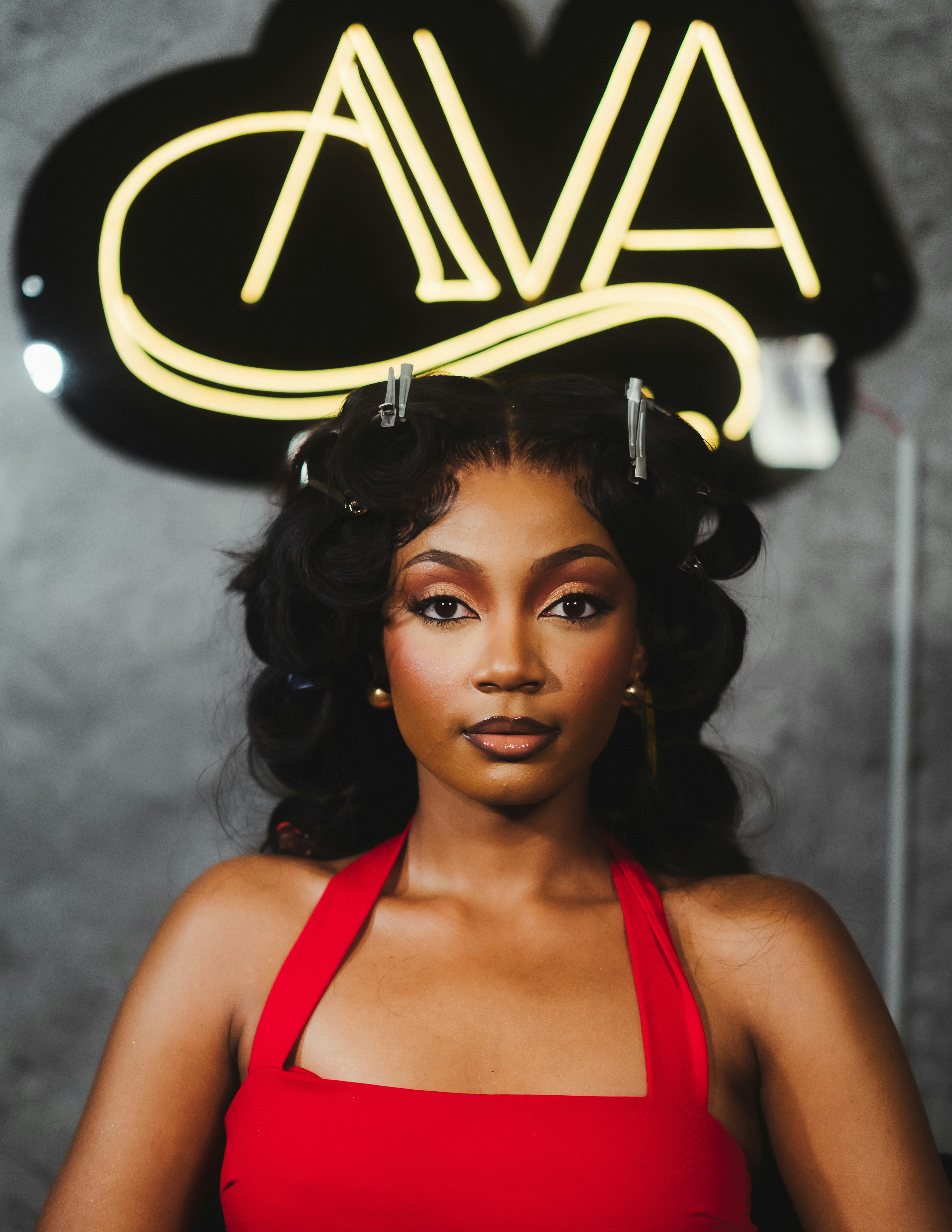 Glow in Red: Portrait Beneath the AVA Neon Emblem