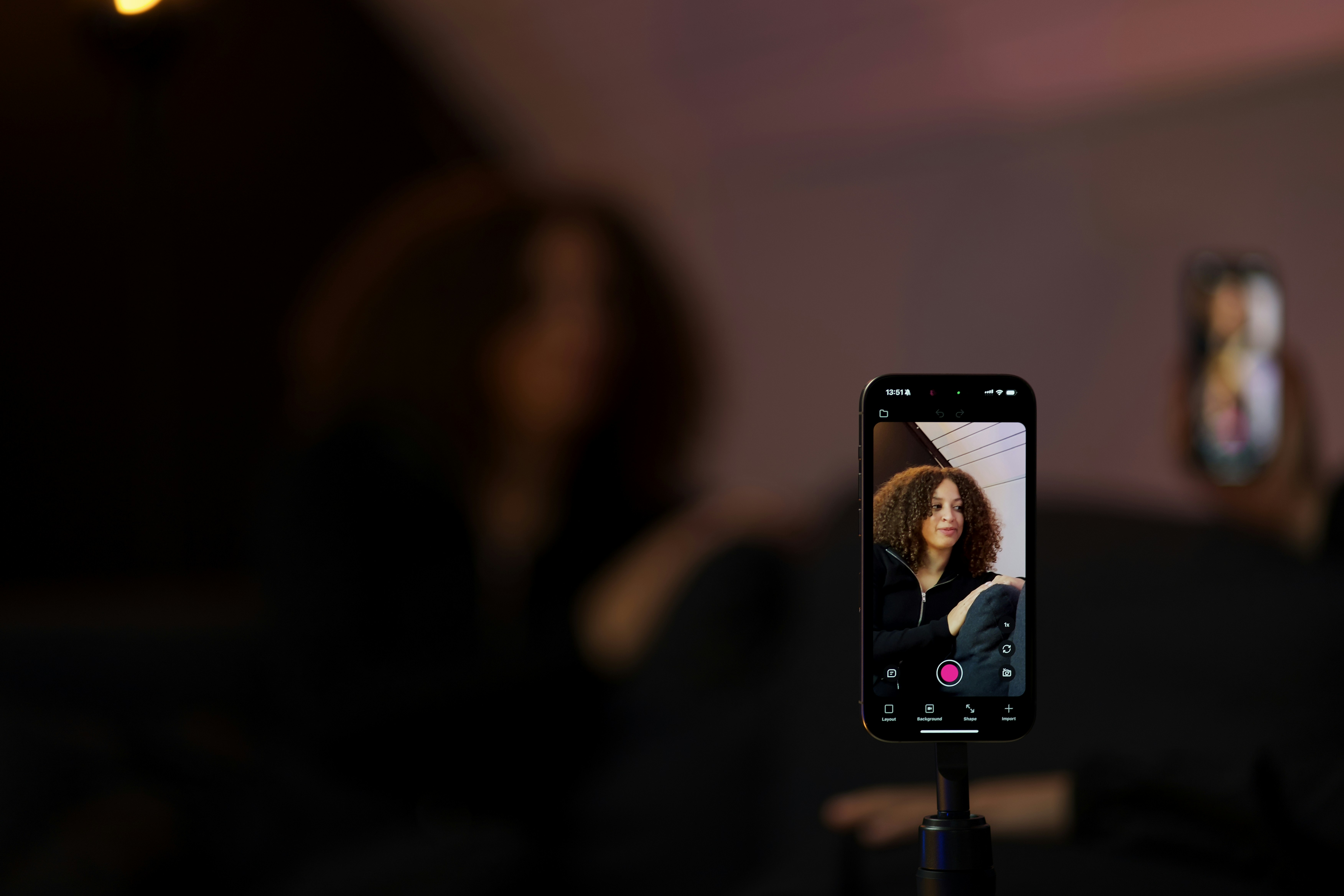 Dim-Lit Studio: A Phone-Screen Livestream Framing a Quiet Living Room Session