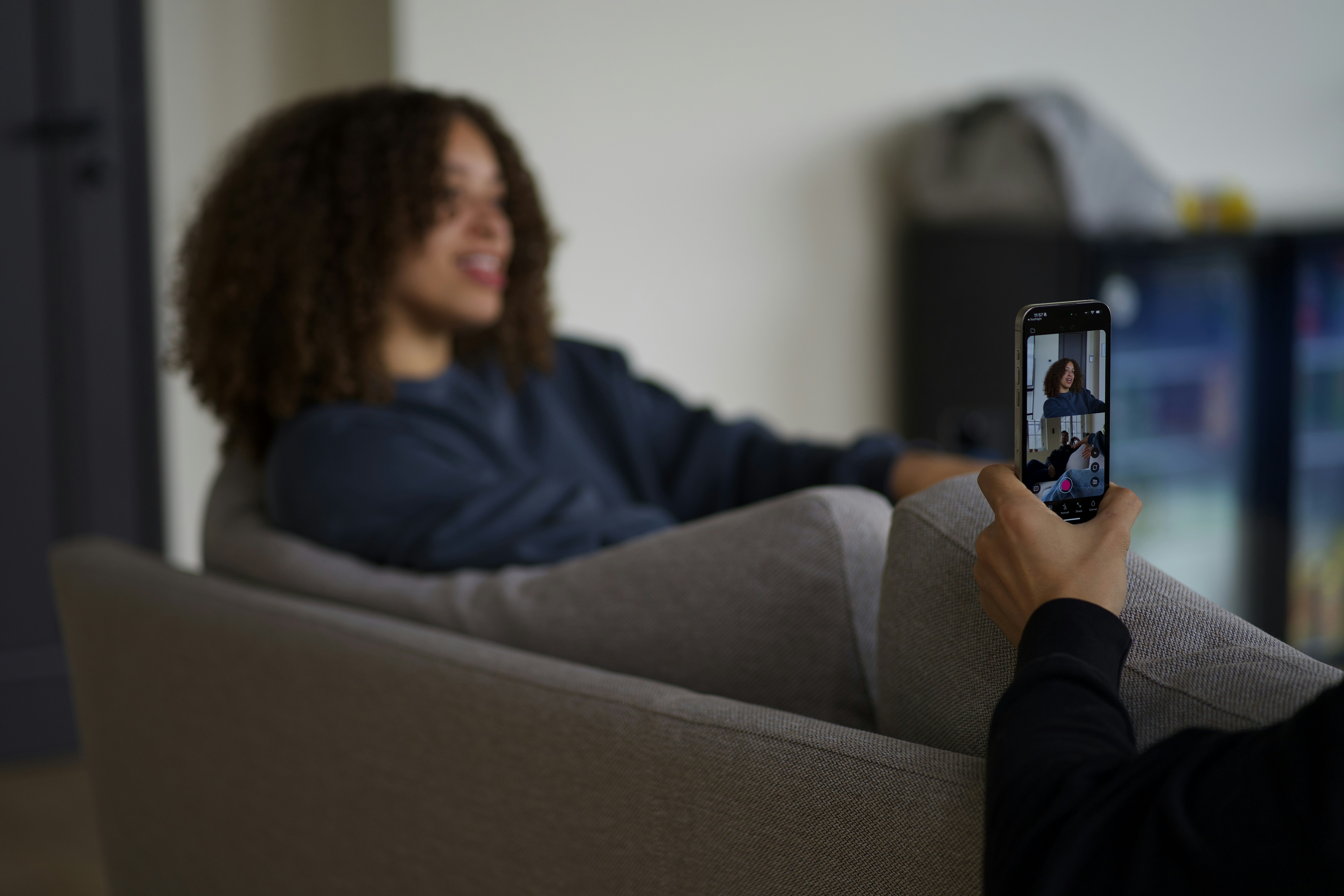 Cushion Conversation: A Warm Moment Framed by a Phone Screen