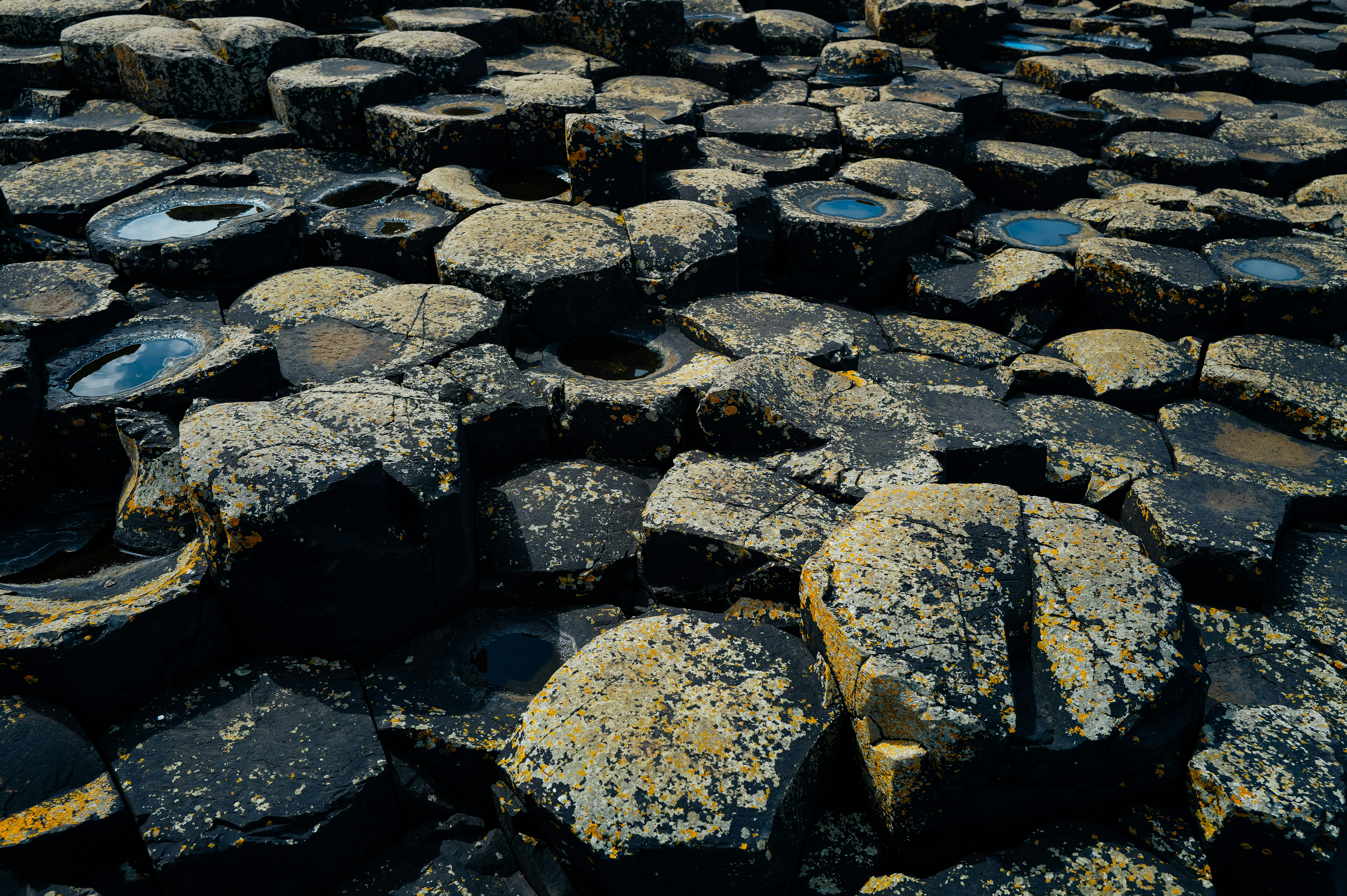 Hexagonal basalt columns on a rocky shore. photo – Free Stone Image on ...