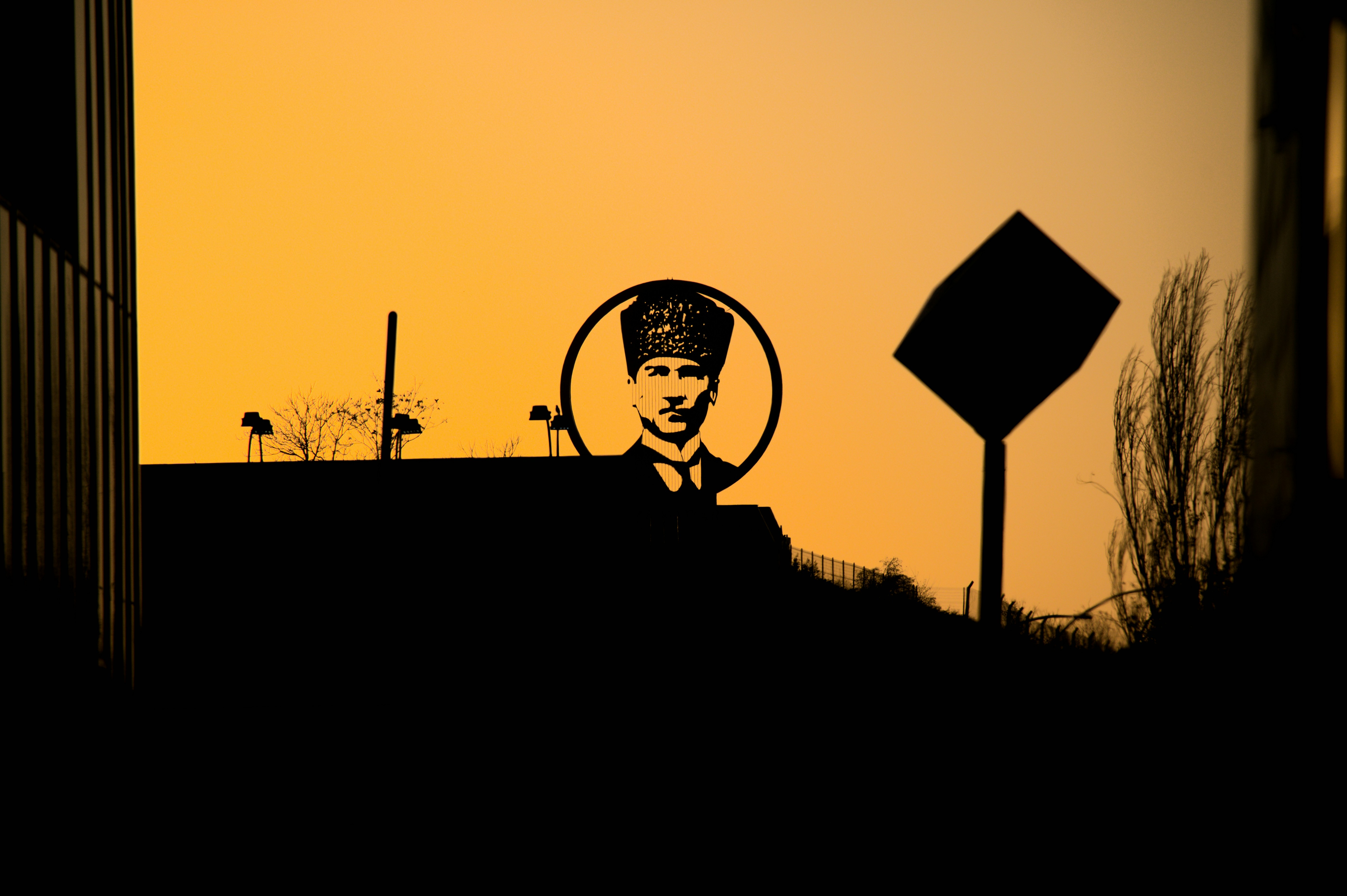 Halo over the Horizon: Circular Emblem Silhouette at Dusk