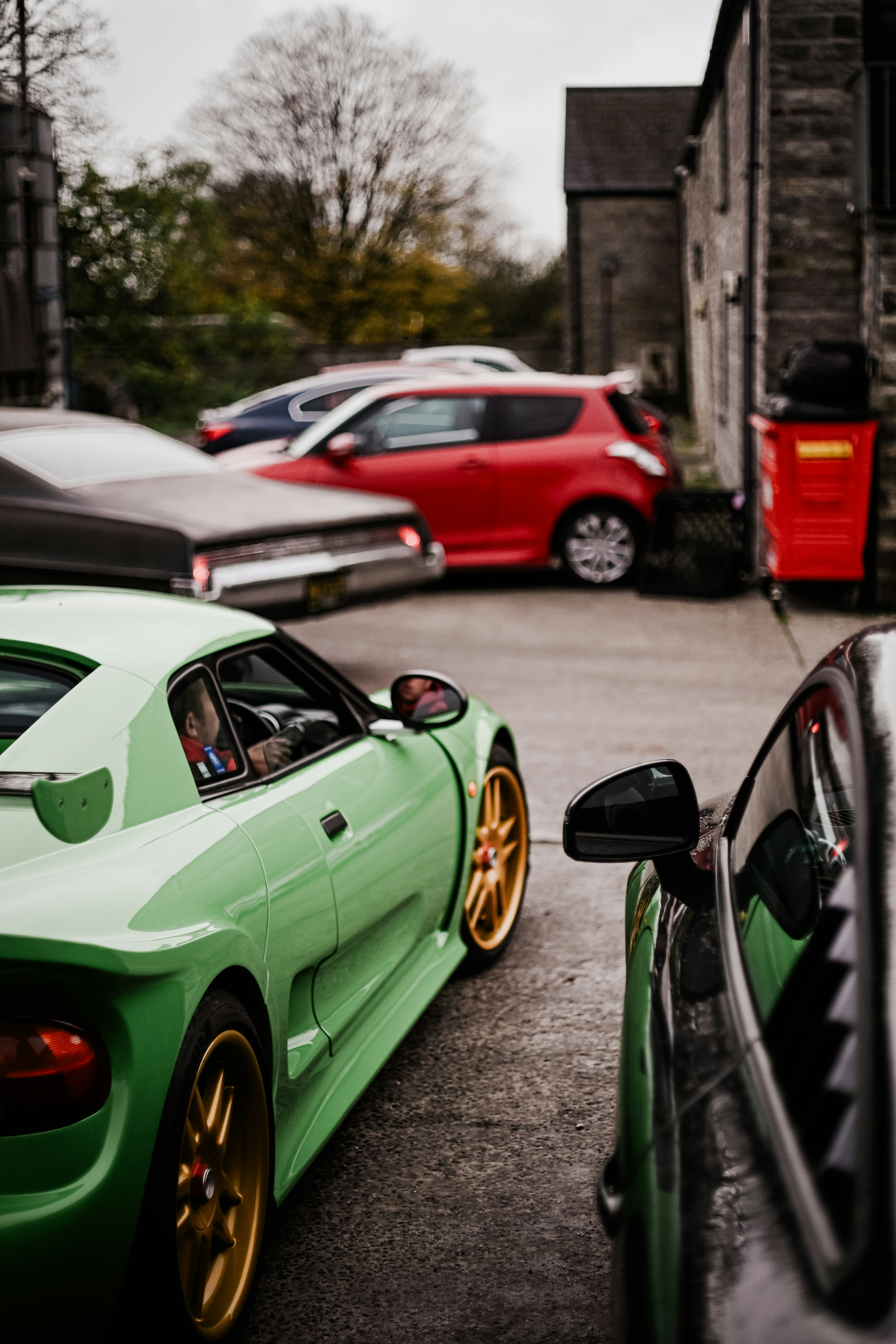 Emerald Velocity: Lime-Green Racer with Golden Wheels in a Quiet Parking Lot