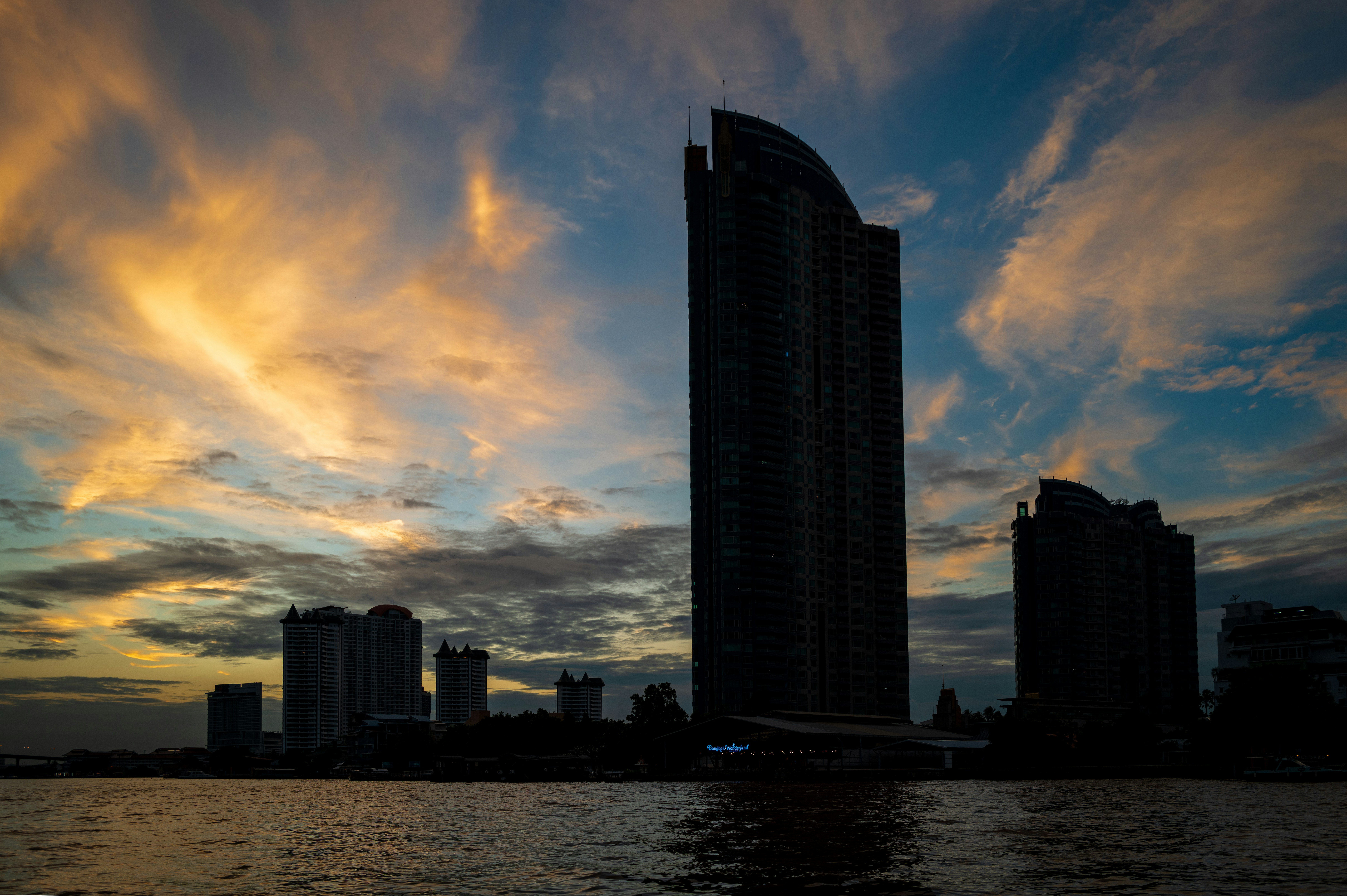 Dusk Over the Harbor: Tall Shadows Against a Fiery Sky