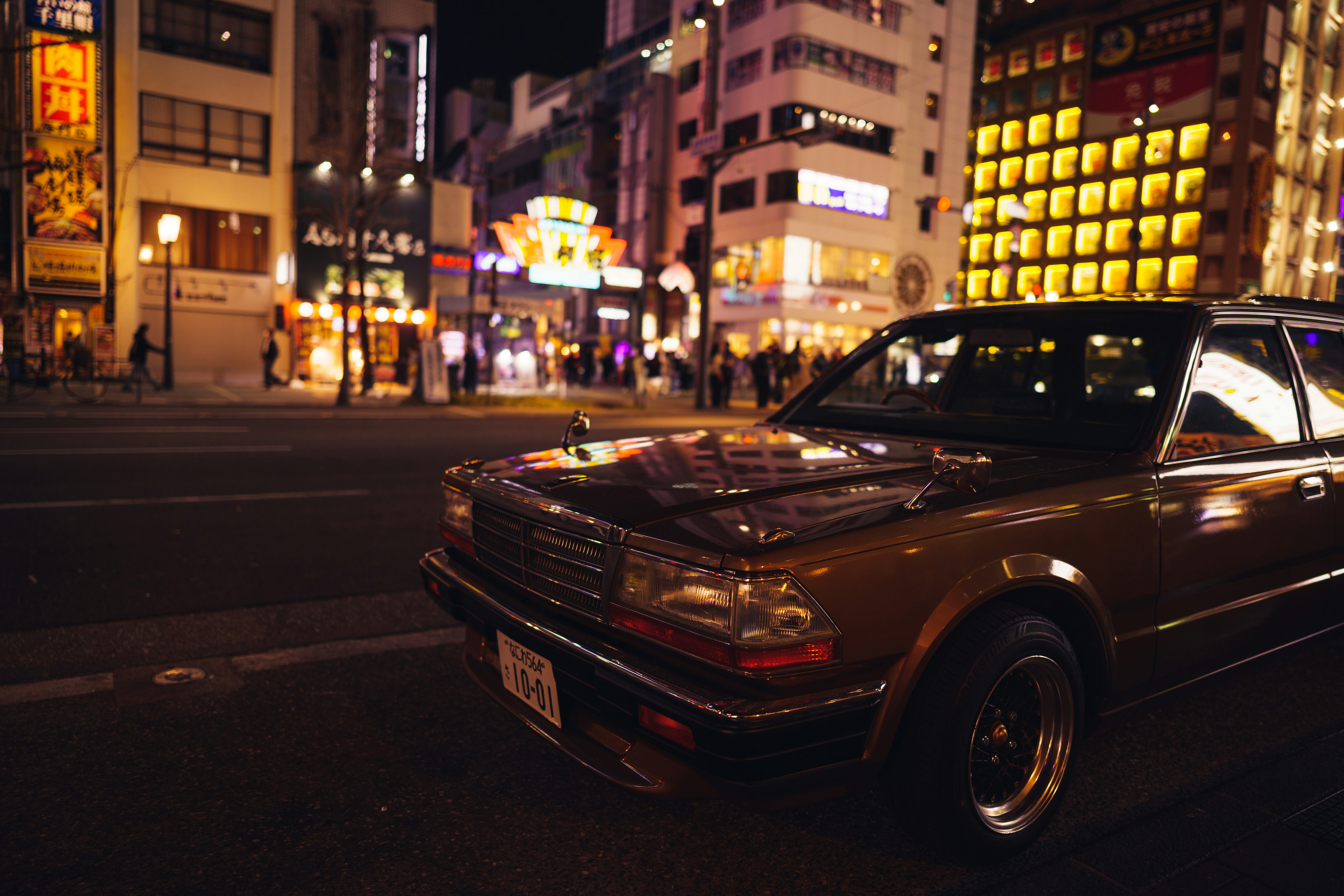 Neon Noir: A Vintage Sedan Anchored by City Lights