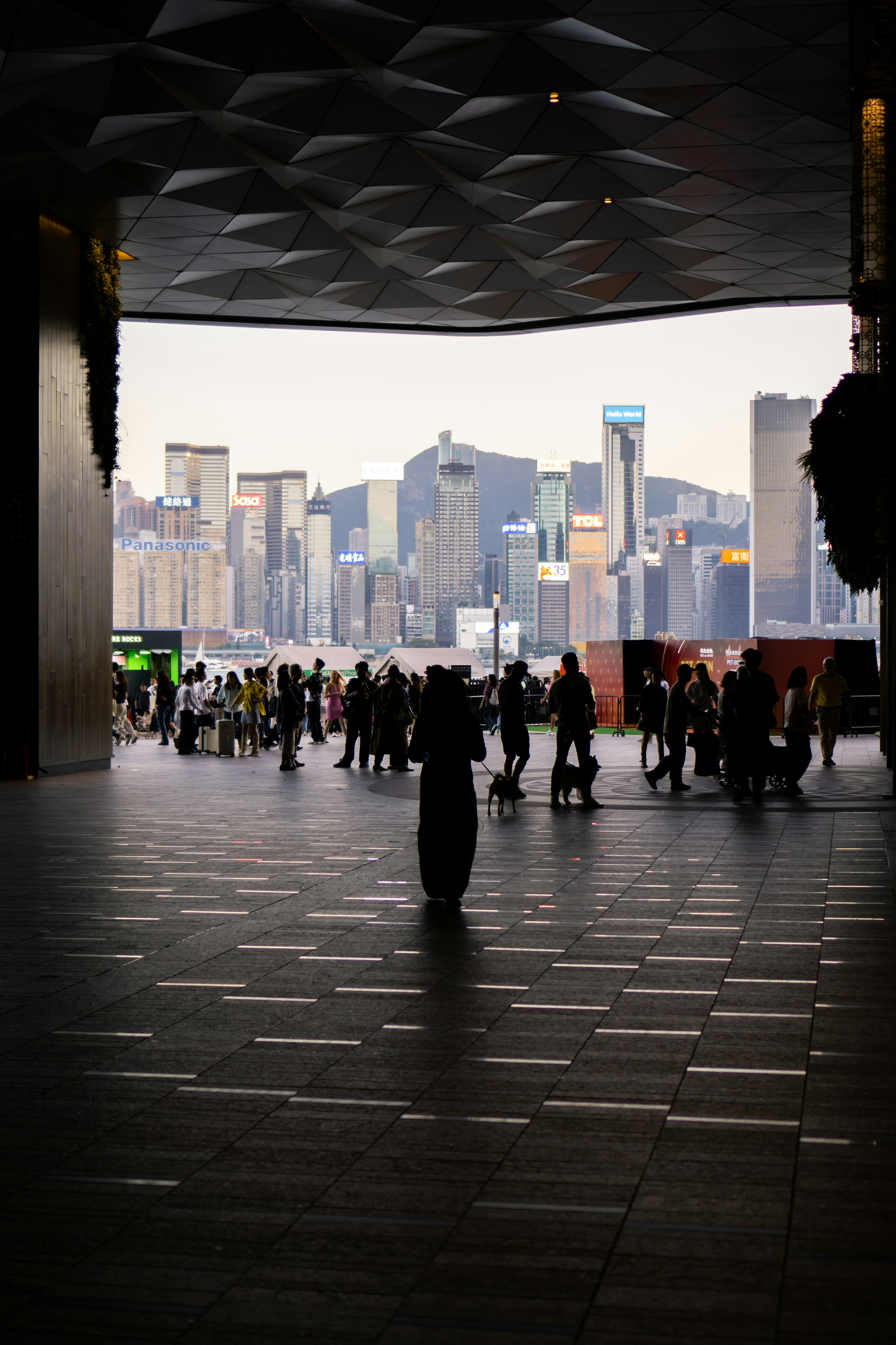 Under a Diamond Ceiling: Cityscape framed by a crowd beneath a faceted canopy