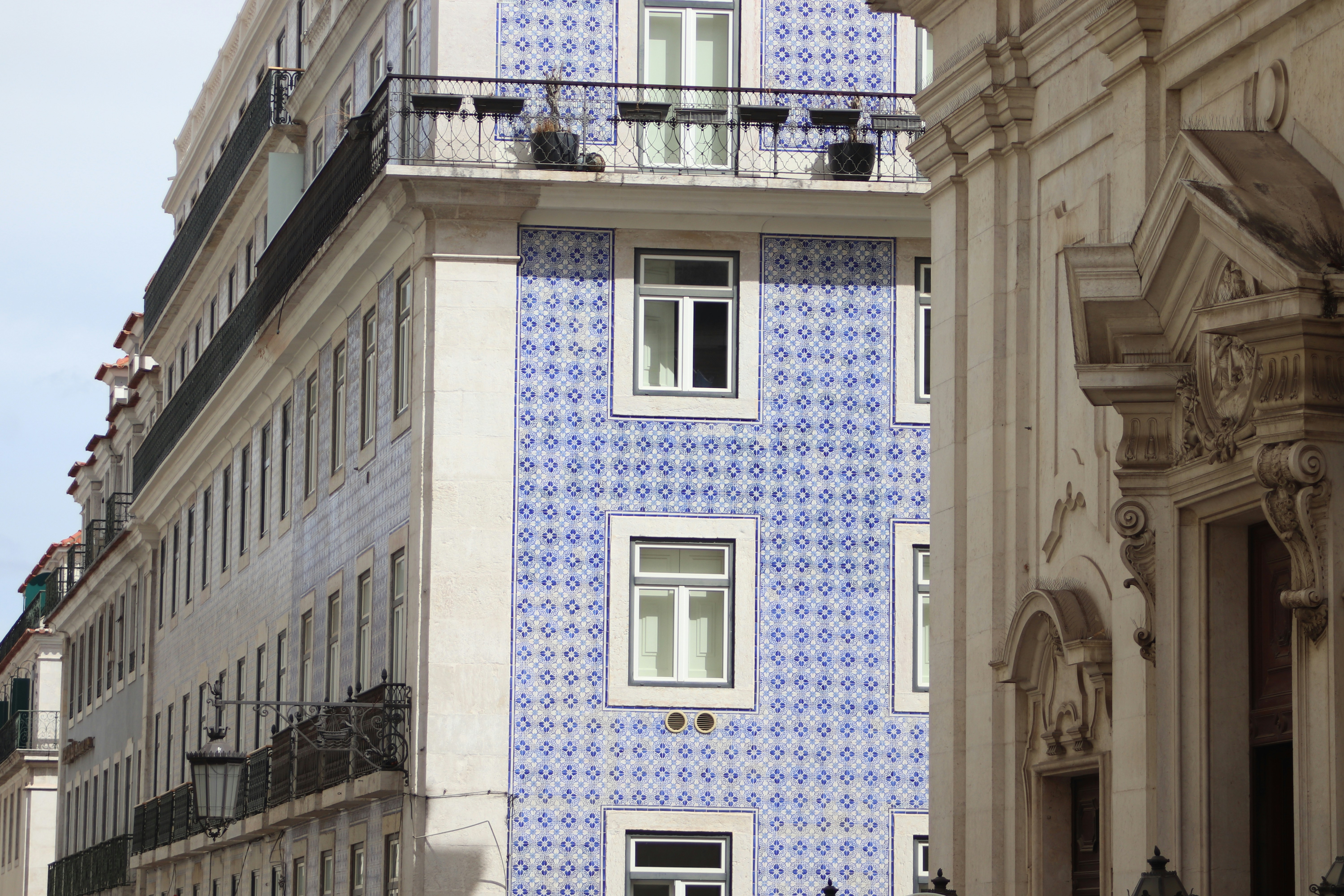 Lisbon's Blue Azulejo Facade: Tilework Framed by Stone and Arch
