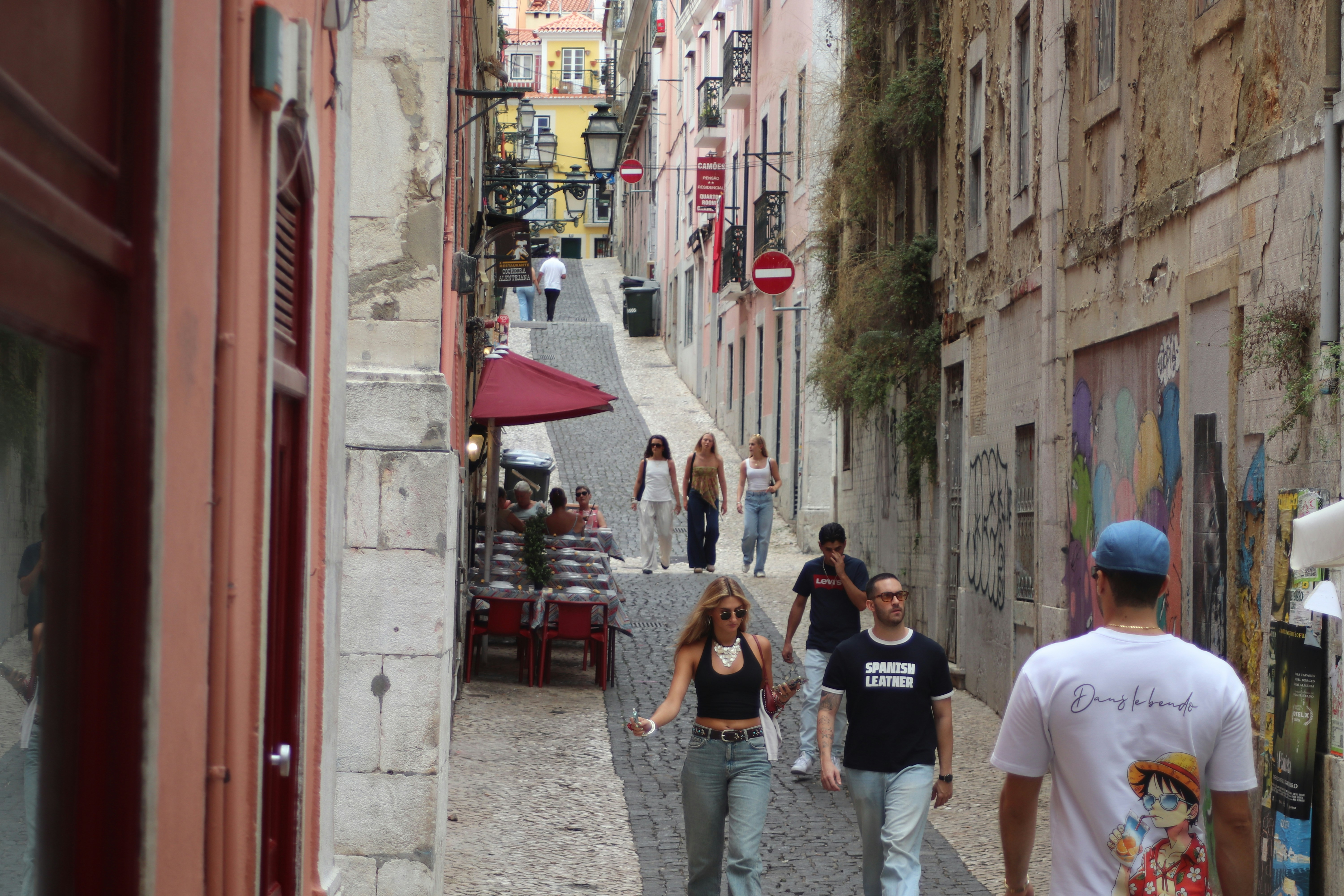Sunlit Ascent Through a Historic Cobblestone Alley